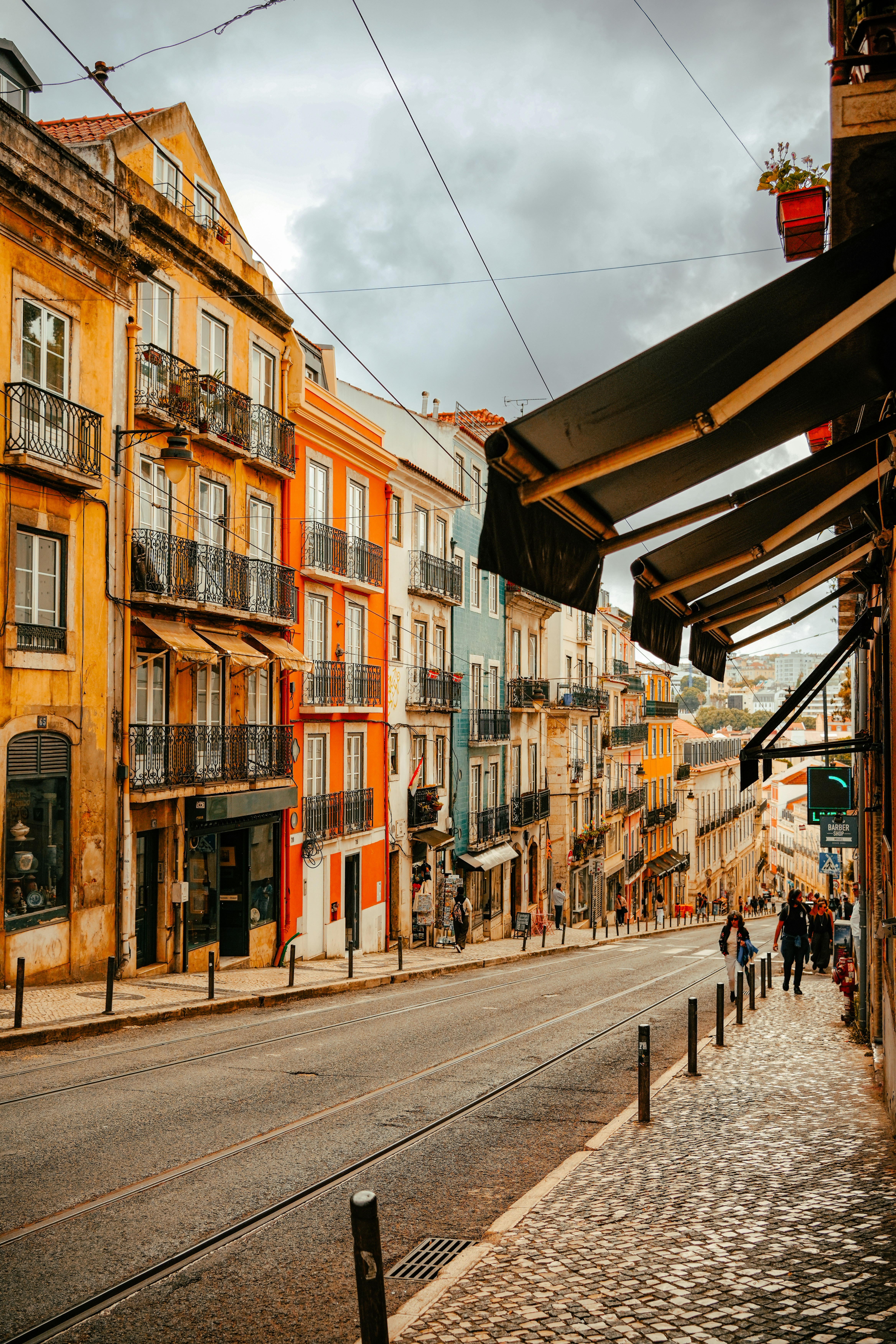 Colorful Facades marching down a hillside street in a sunlit European boulevard