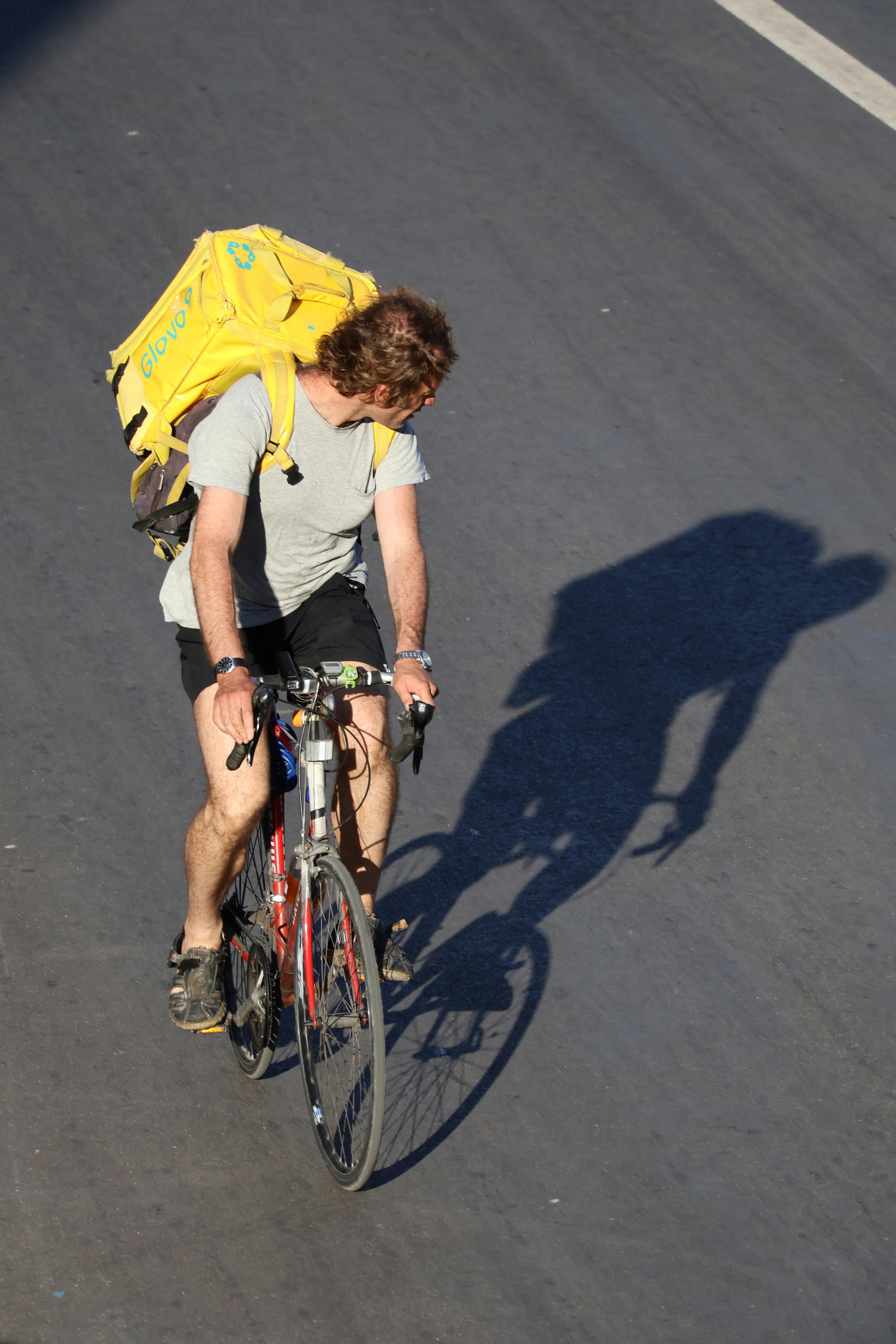 Cyclist in Motion: A Pinned Shadow on the Road