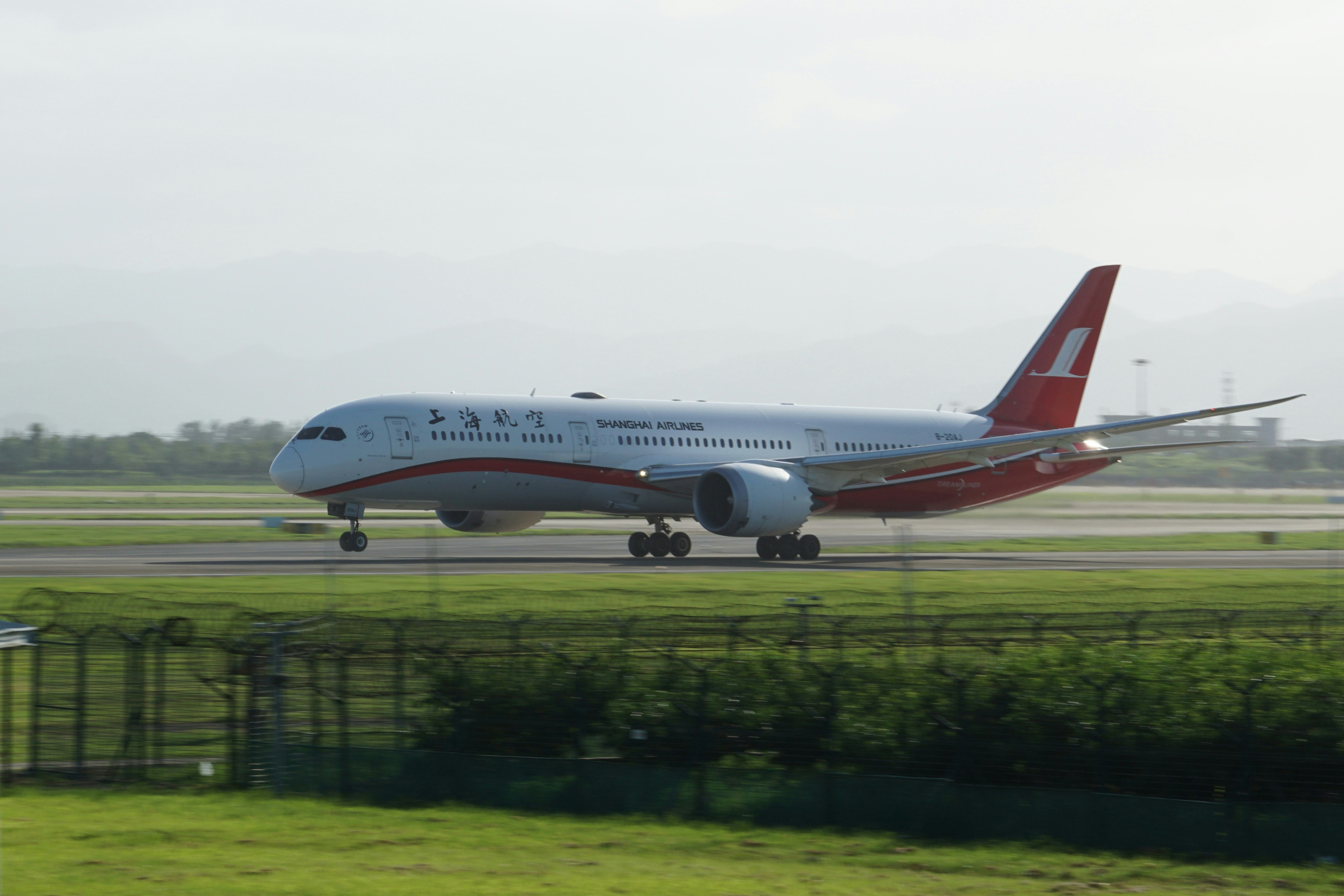 Red-and-White Jet Ready for Takeoff on a Quiet Runway