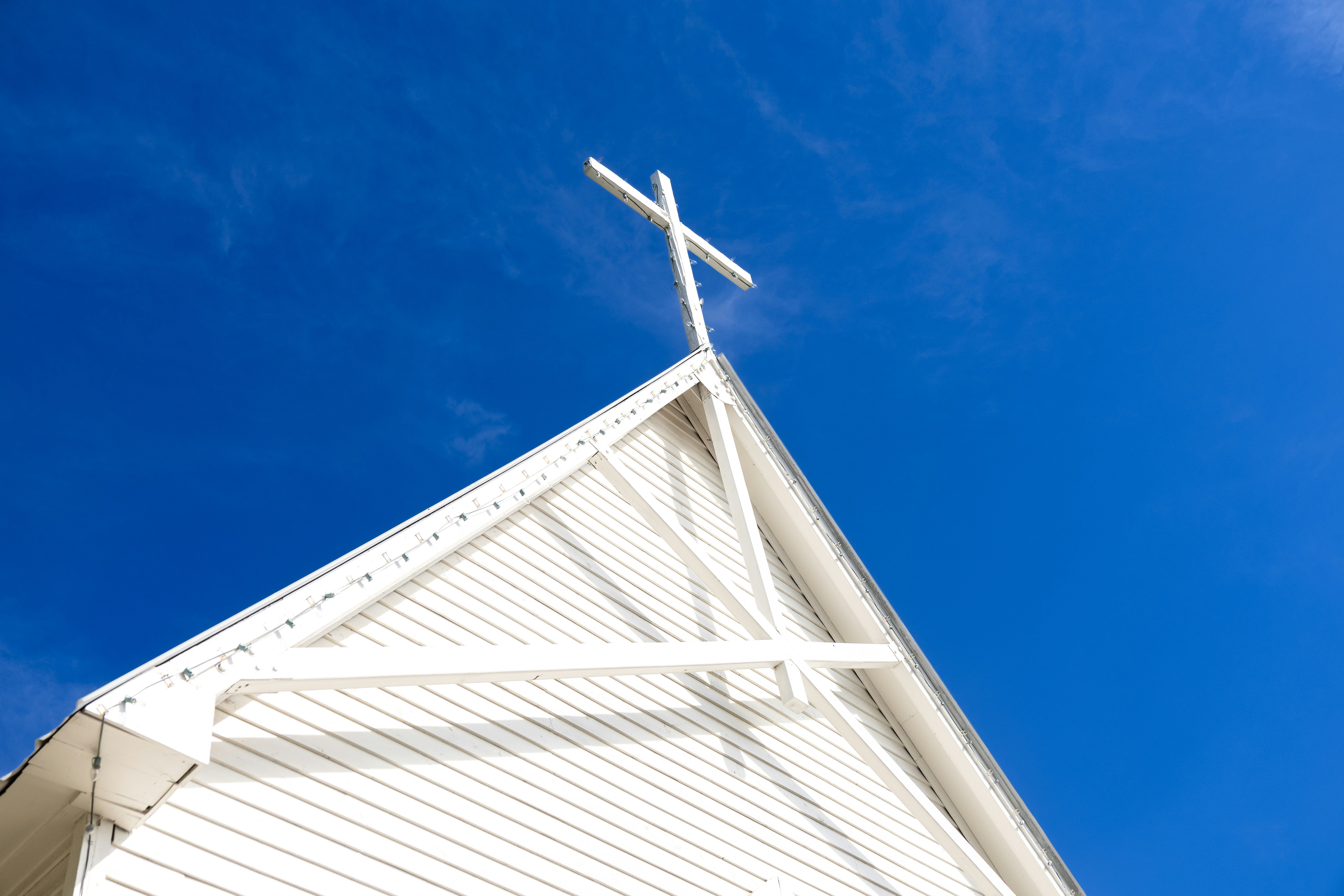 Cross atop the White Chapel under a Cerulean Sky