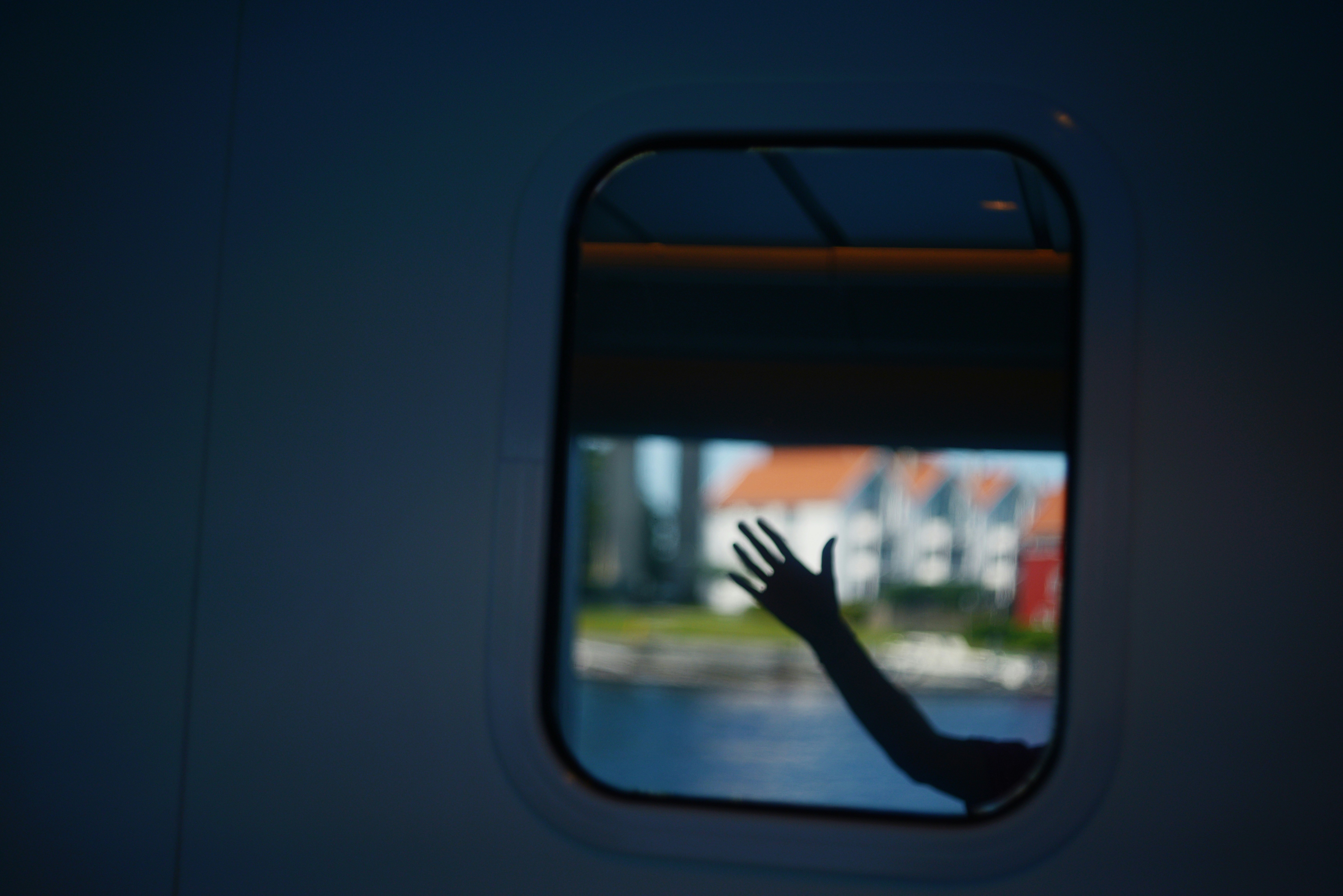 Through the Window: A Shadowed Hand Reaches from the Cabin