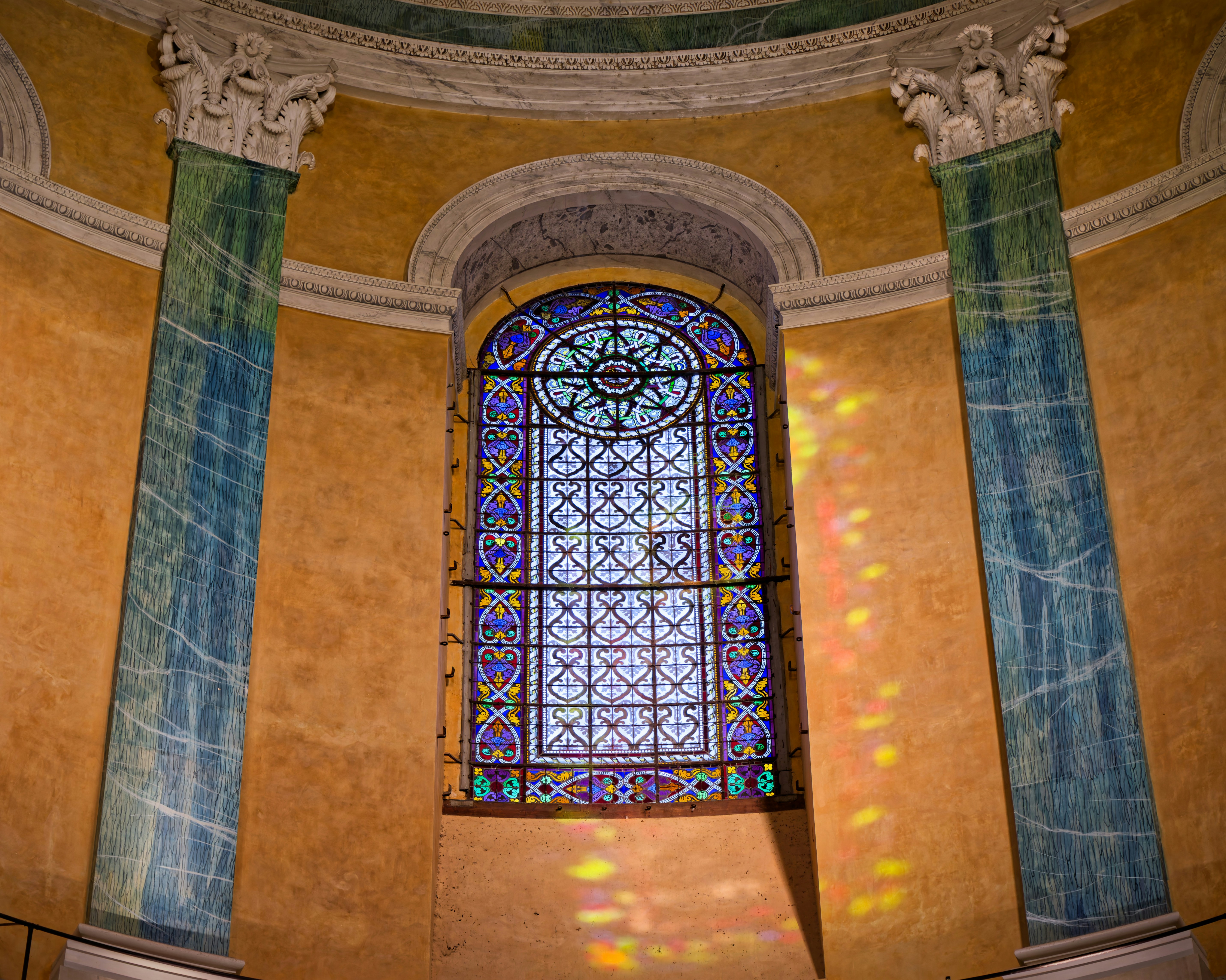 Stained Glass Beacon Between Marble Pillars