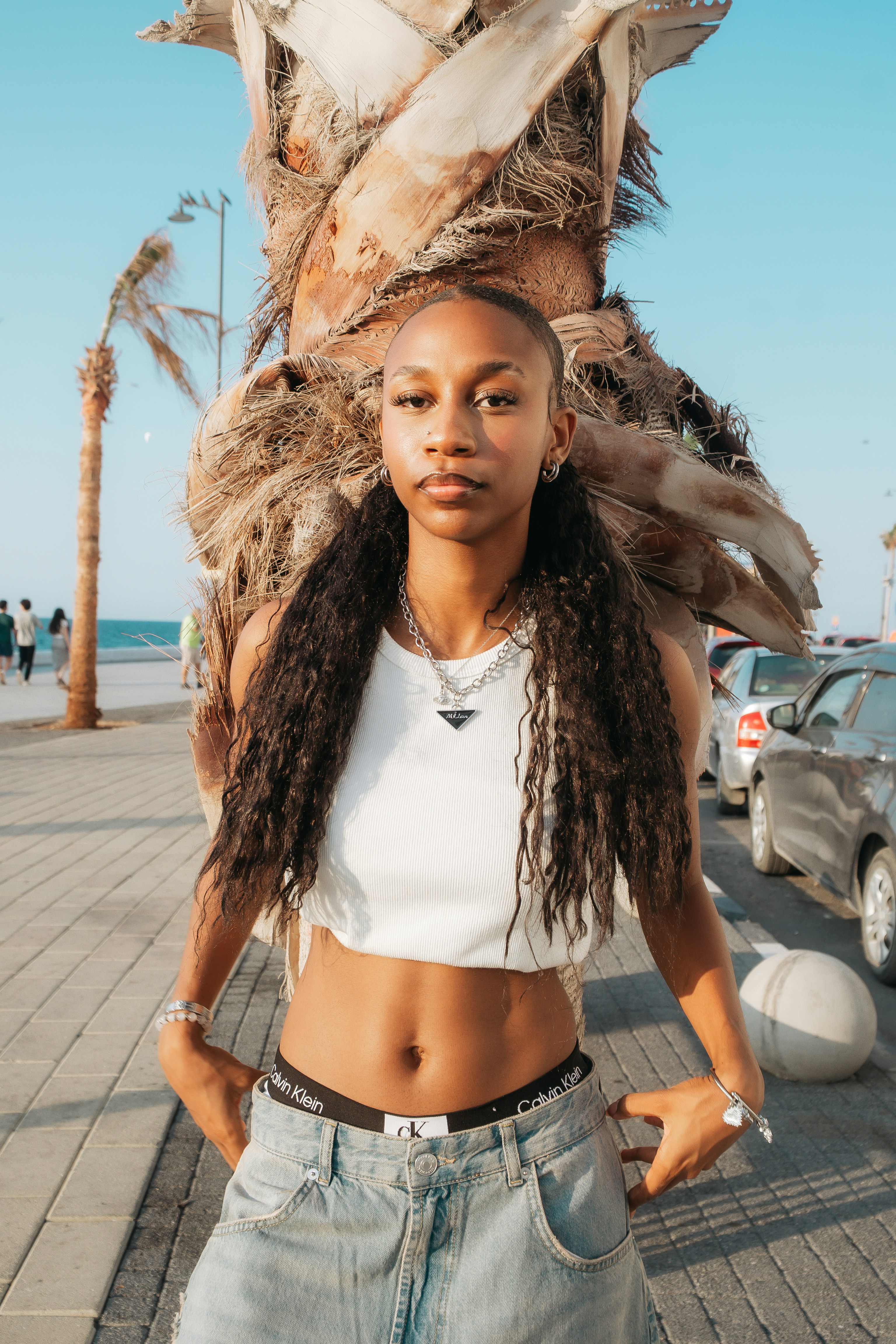 Portrait Under Palm: Confidence at the Seaside Walkway