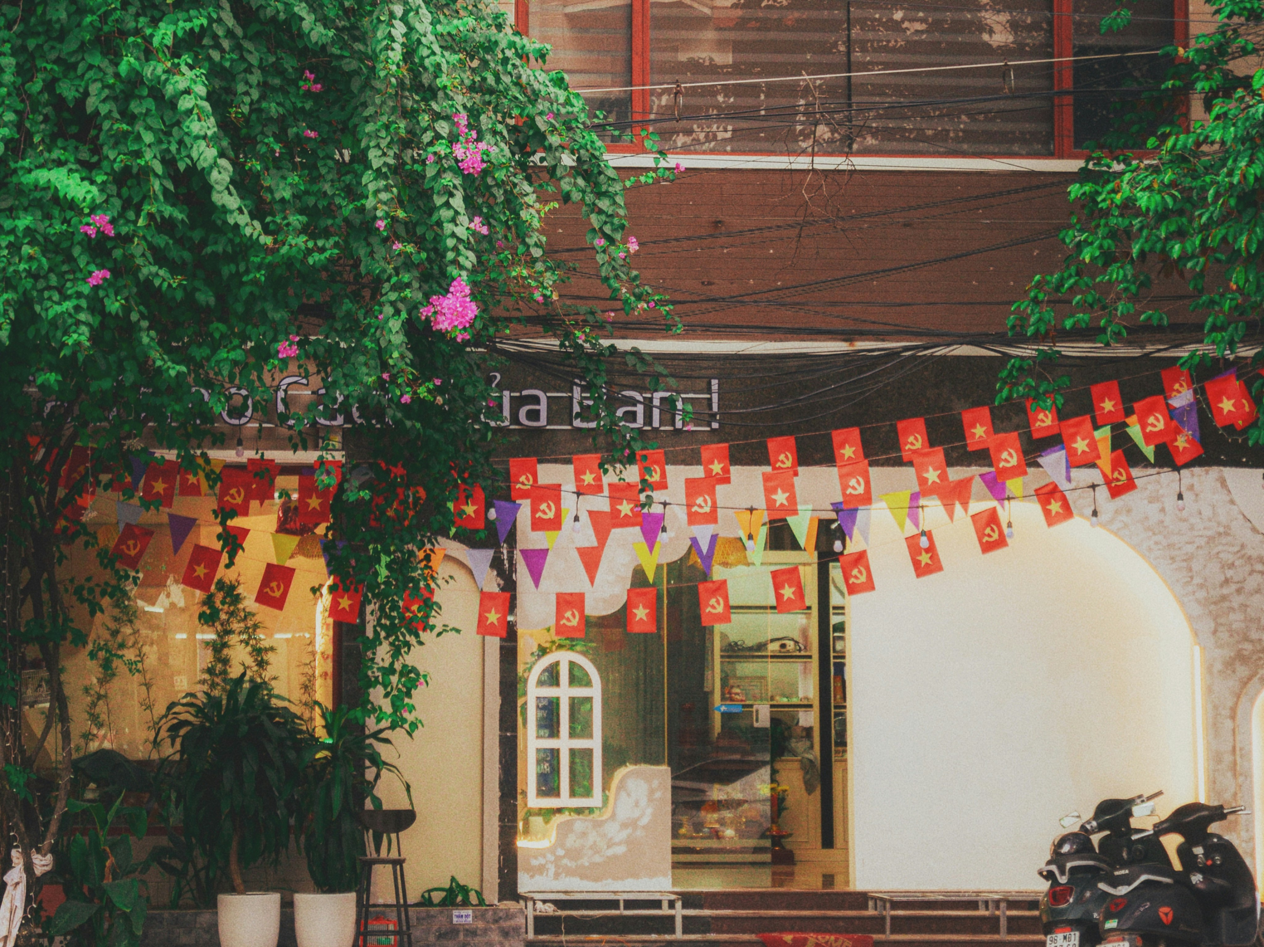 Festive Flags Over a Courtyard Storefront