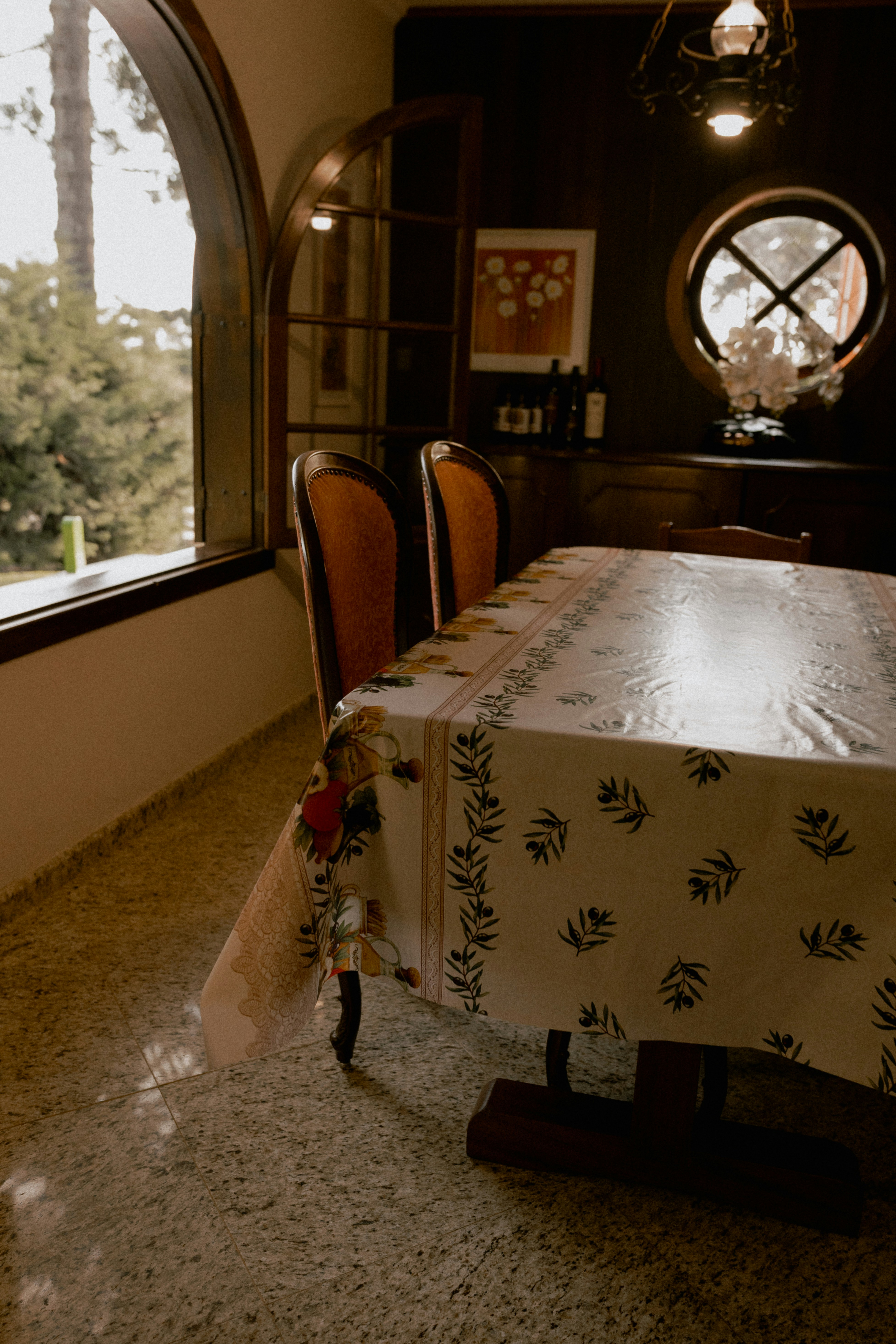 Sunlit Olive-Patterned Table in a Quiet Vintage Dining Room