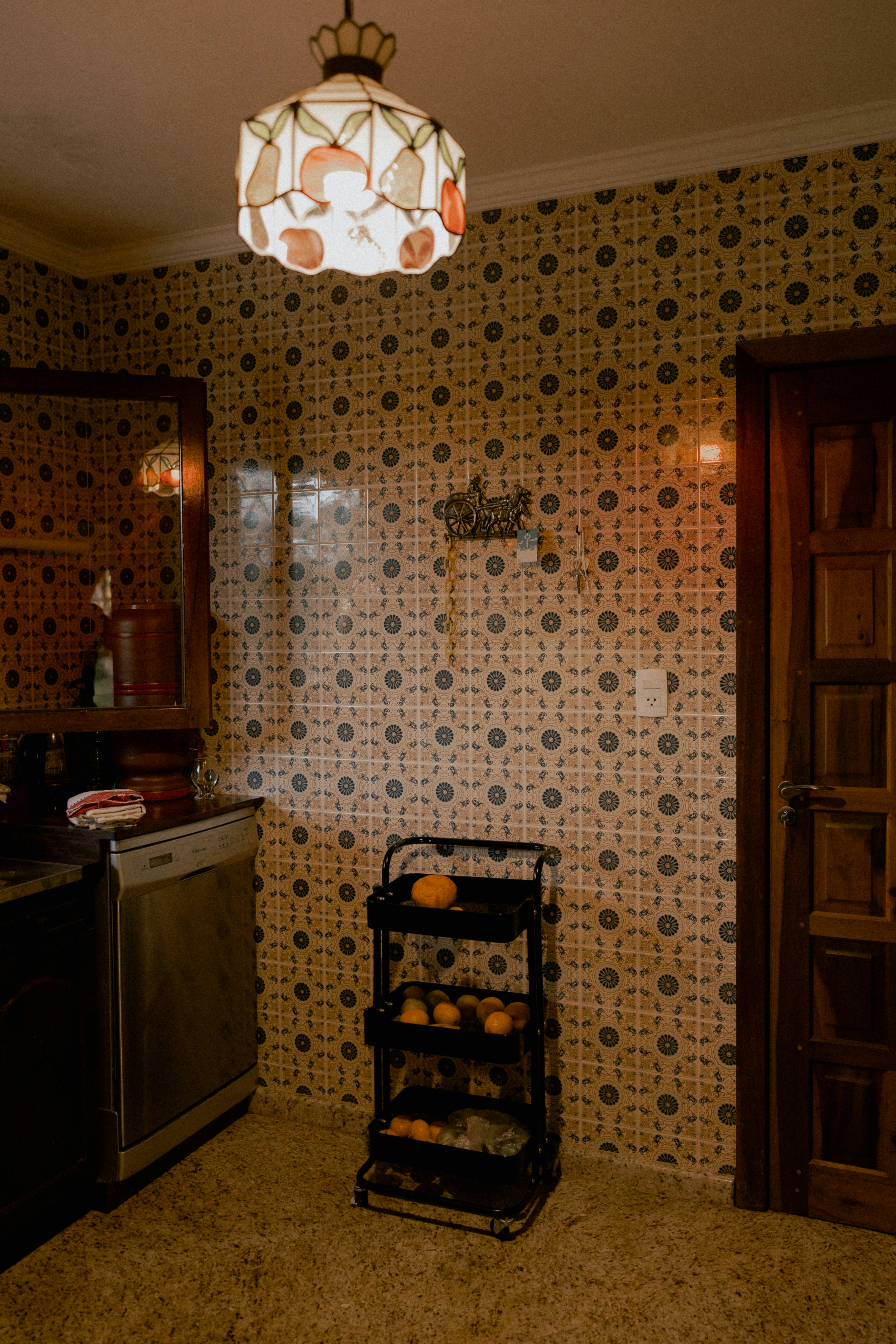 Warm Kitchen Nook with Pepper Stand under Vintage Wallpaper Lighting