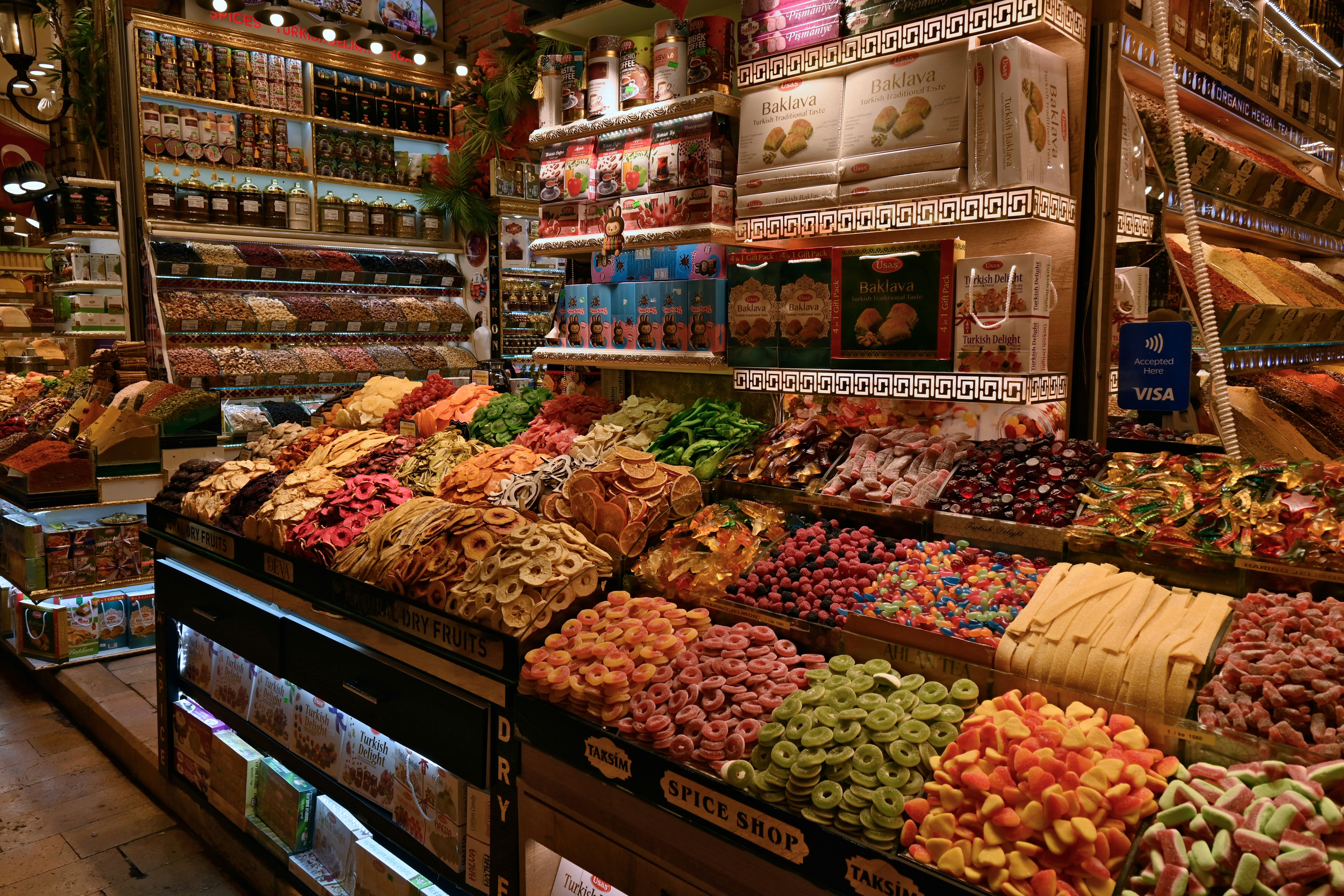 Colorful sweets and dried fruits displayed in a vibrant market.