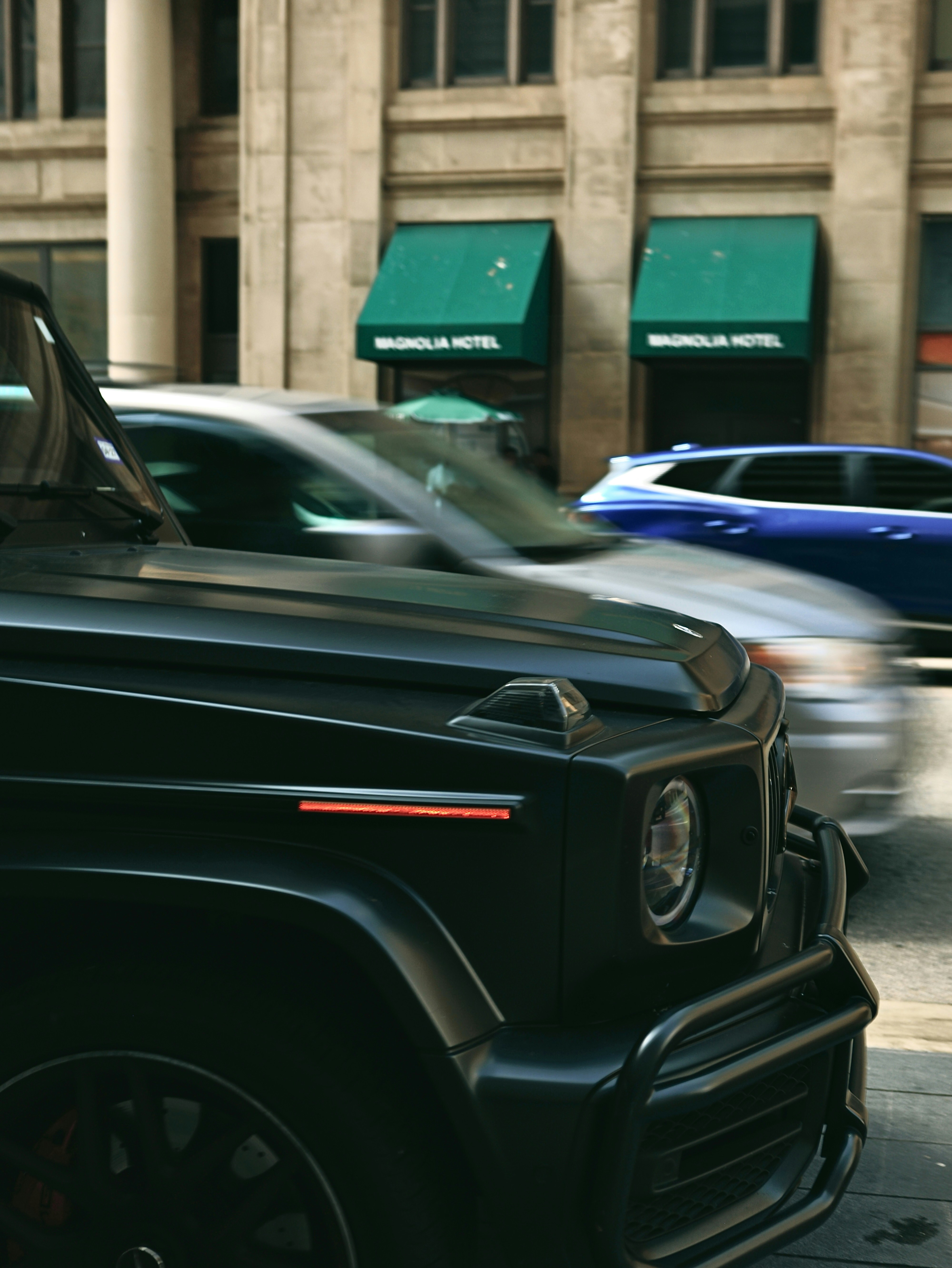 Front Corner of a Bold SUV in Motion Along a City Street