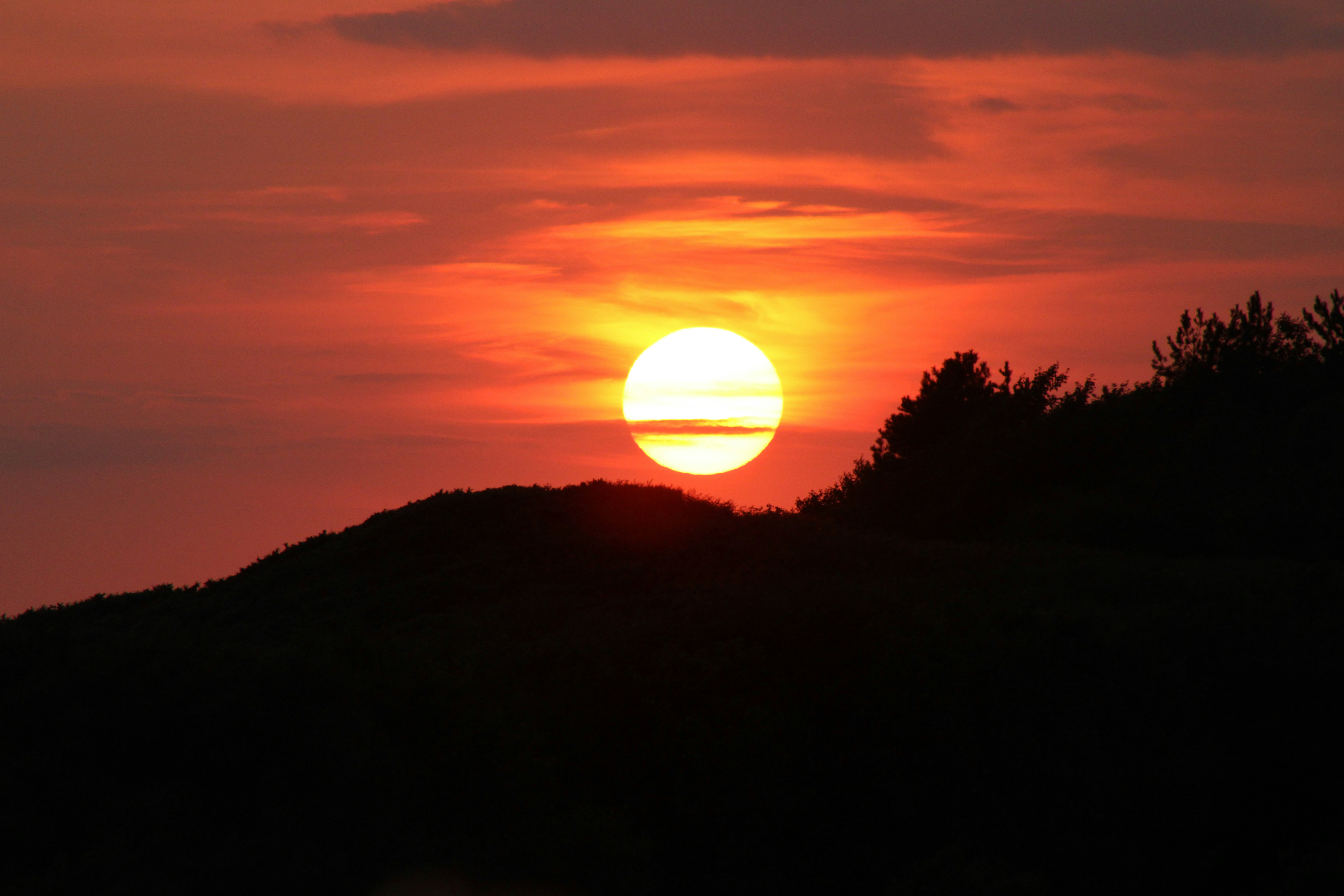 Solar Sphere Over the Ridge: A Quiet Sunset