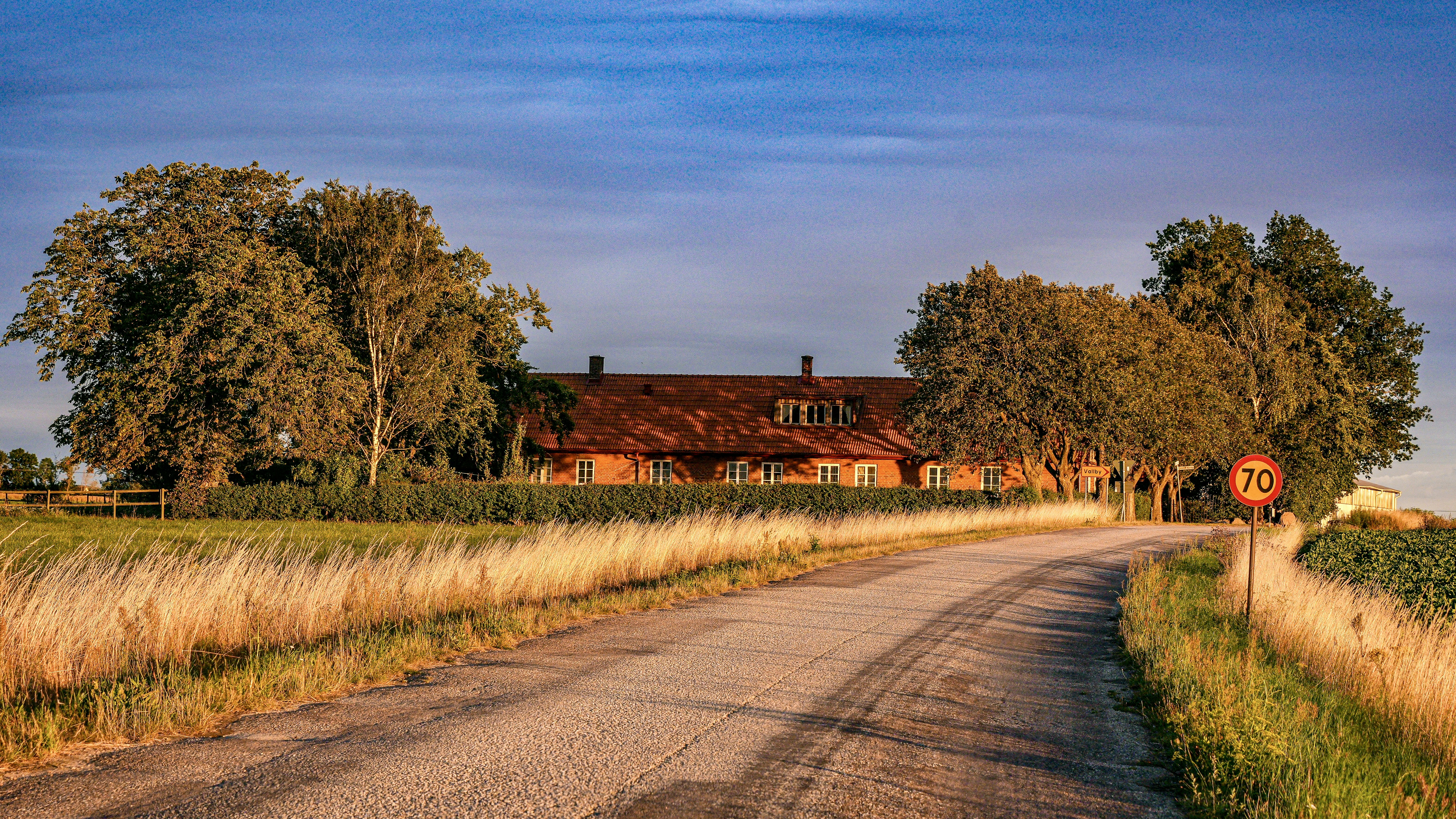 Sunlit Farmhouse on the Quiet Road