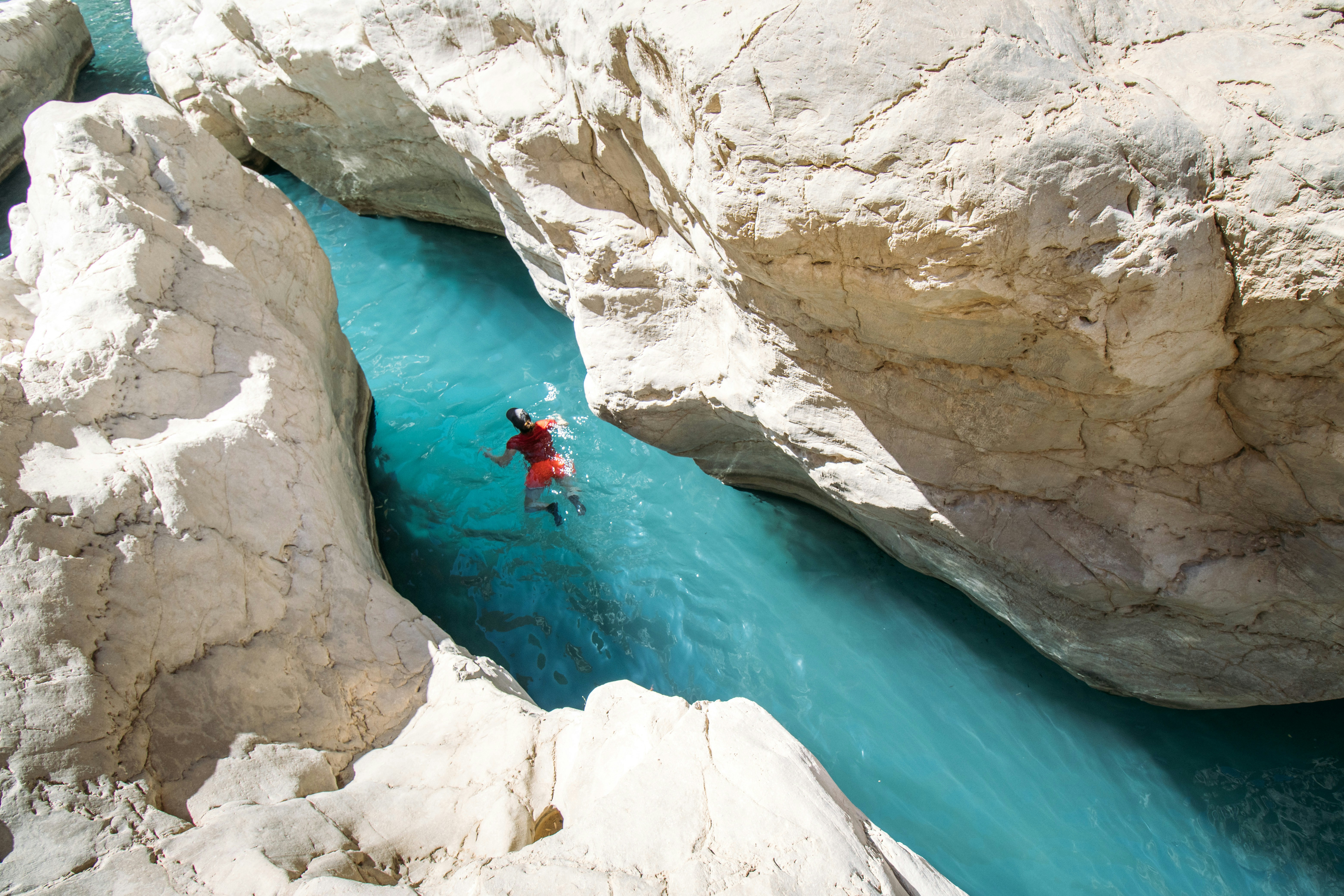 Emerald River Between White Cliffs: A Diver Enclosed by Turquoise Waters