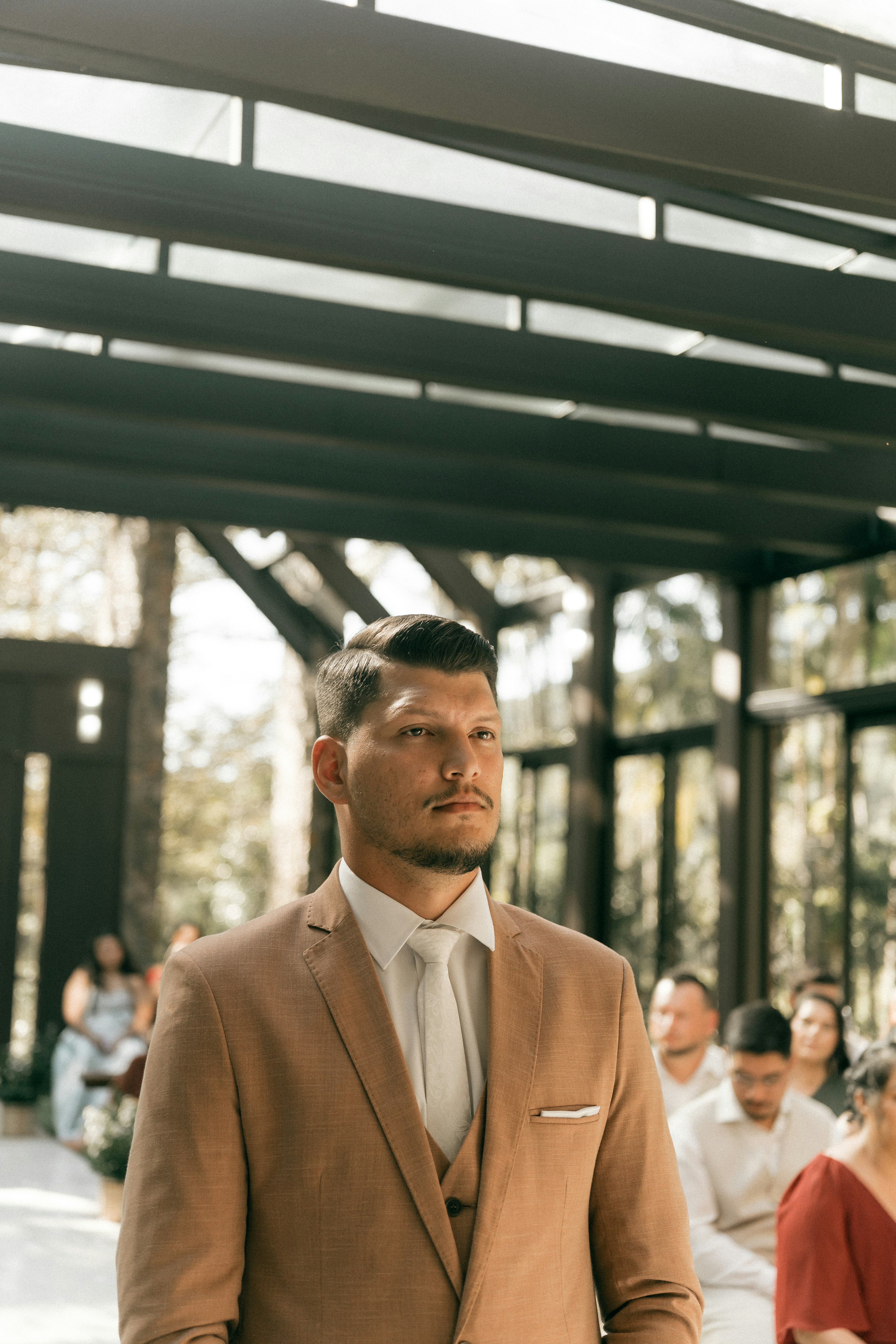 Gentleman in Tan Suit at a Modern Ceremony