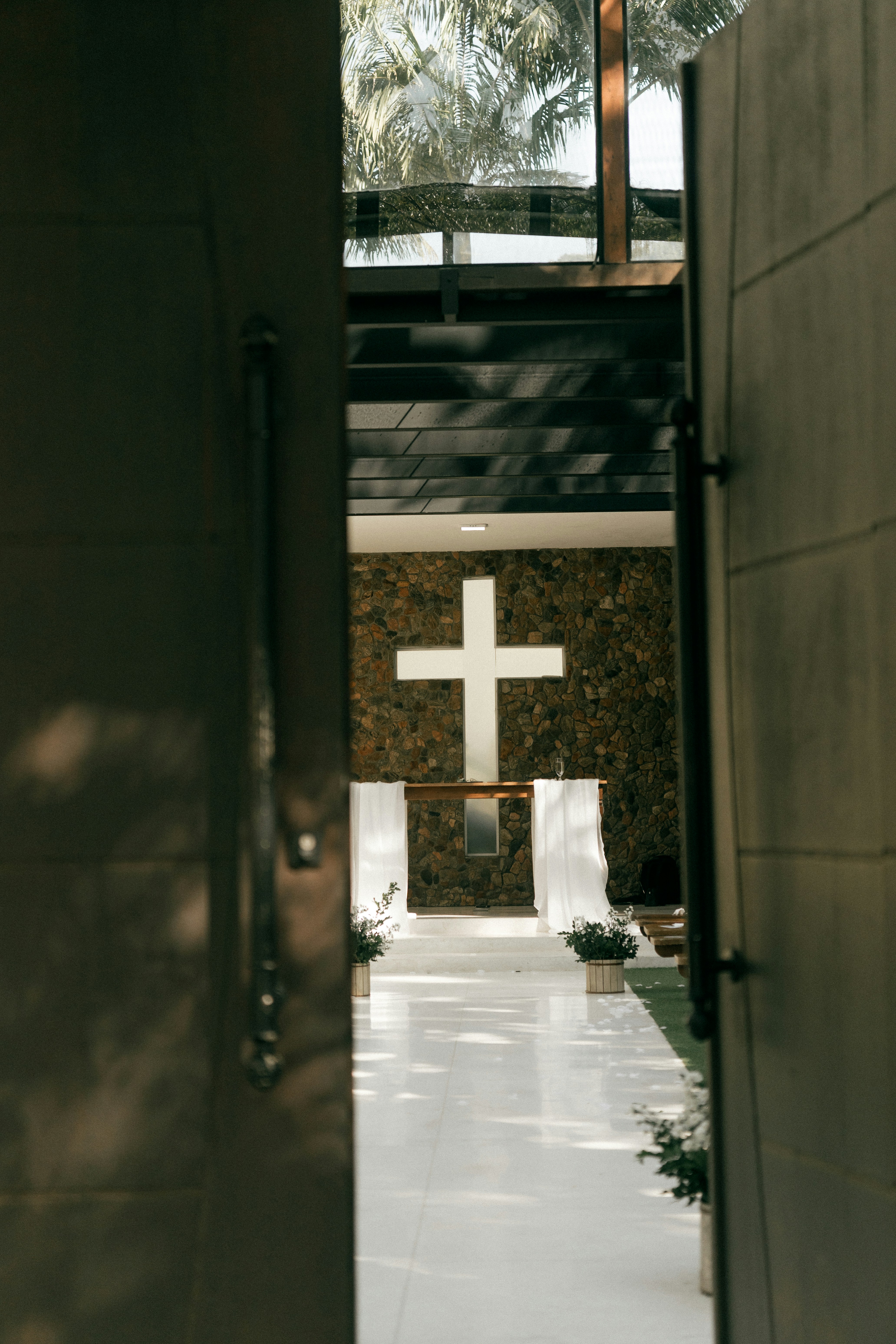 Between Doors: A Sacred Corridor Framed by Light and Cross