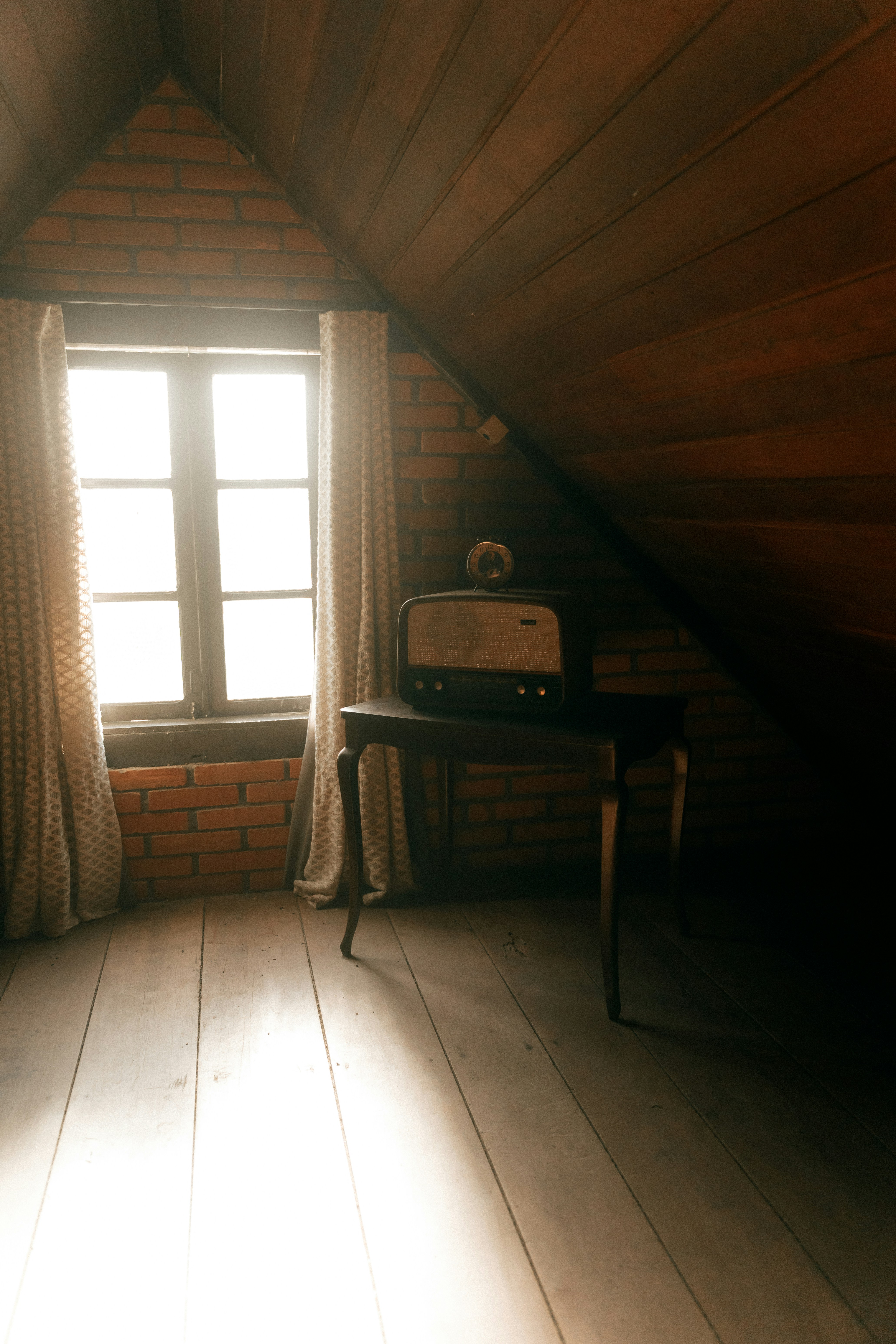 Dormant Glow: An Antique Radio on a Quiet Attic Table