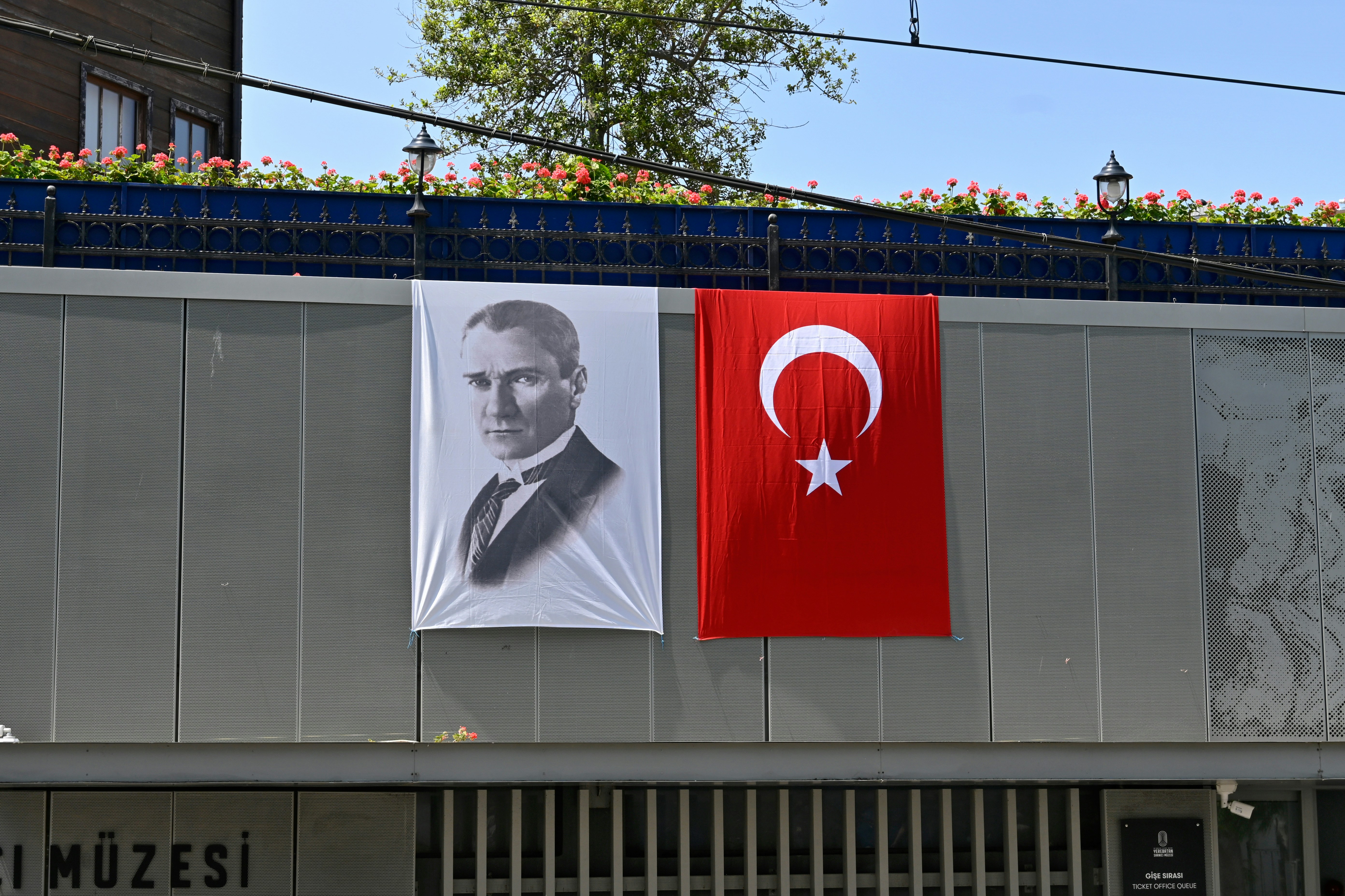 Portrait Banner and Turkish Flag Adorn a Museum Facade