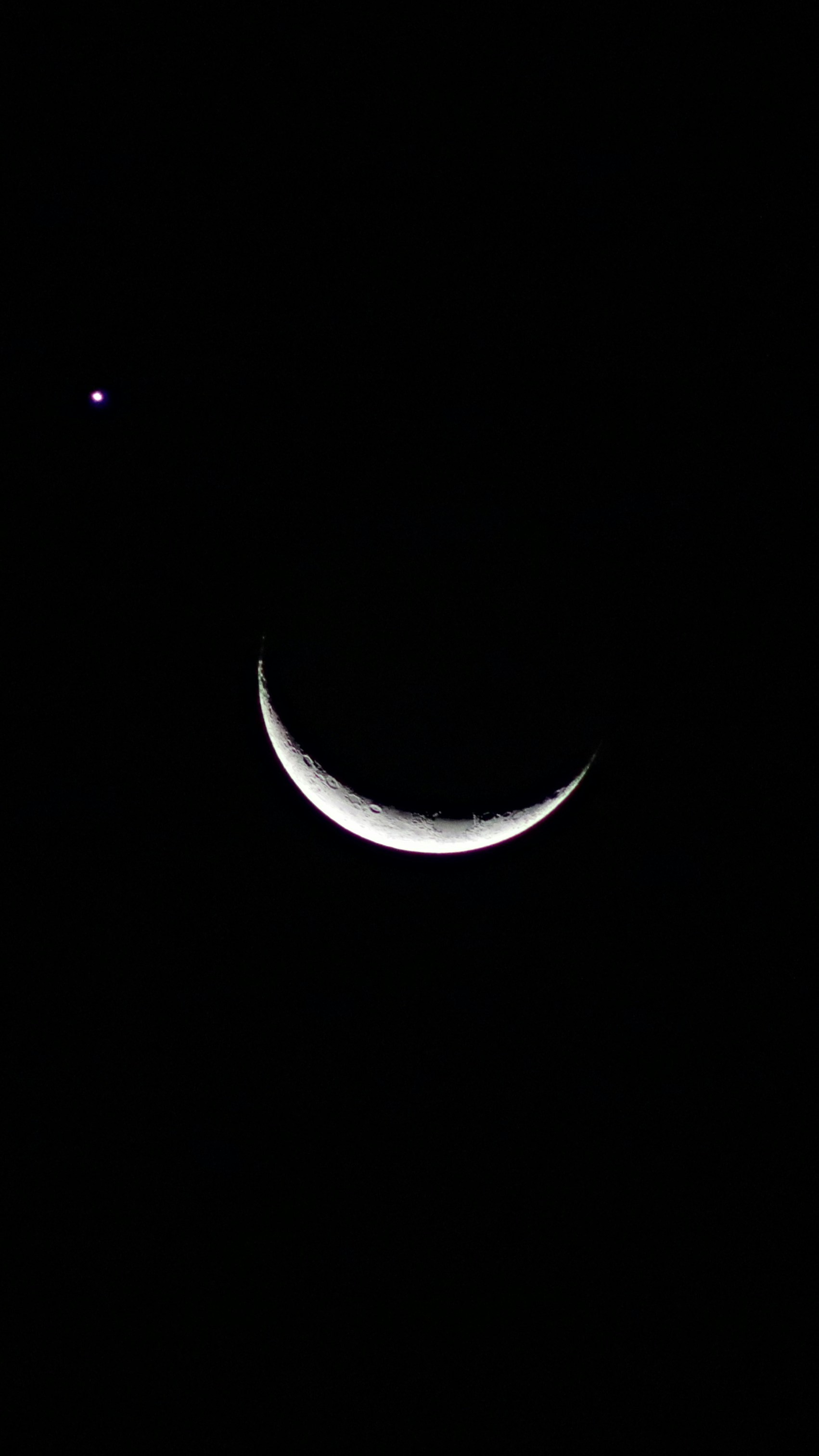 Crescent Moon Over a Quiet Black Sky