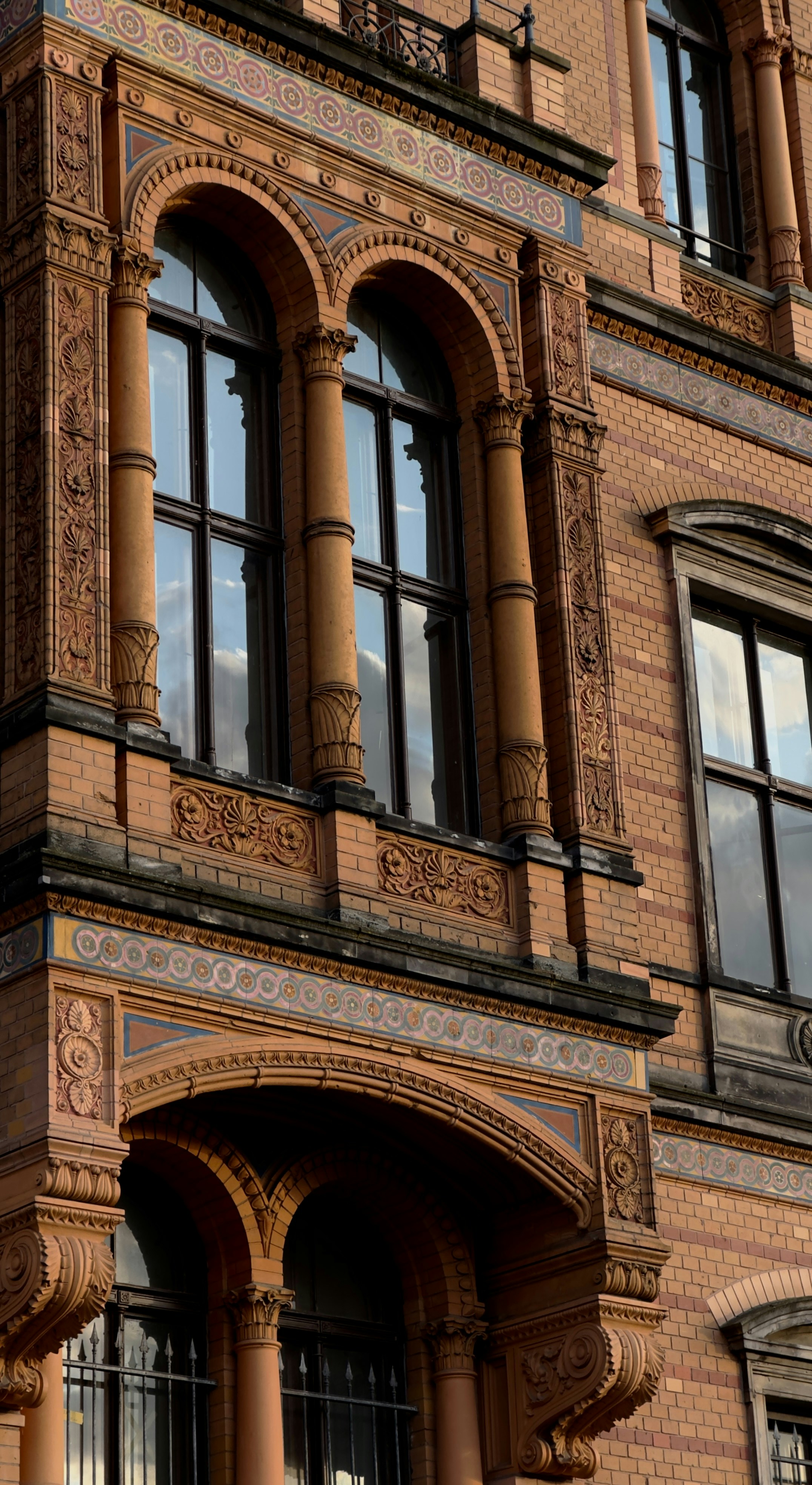 Ornate Brickwork Beneath Arched Windows