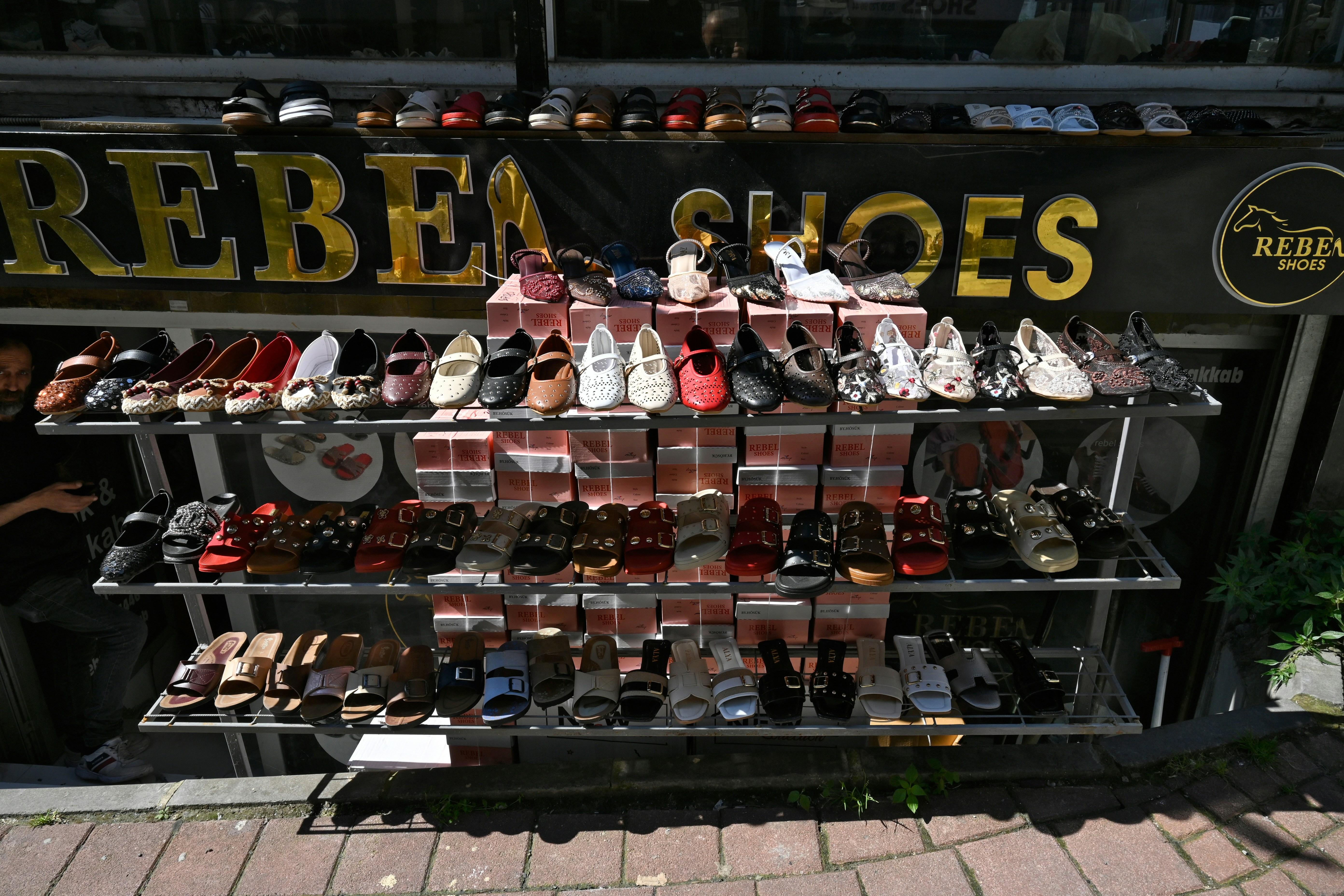 Row of Shimmering Shoes: a storefront display captured at street level