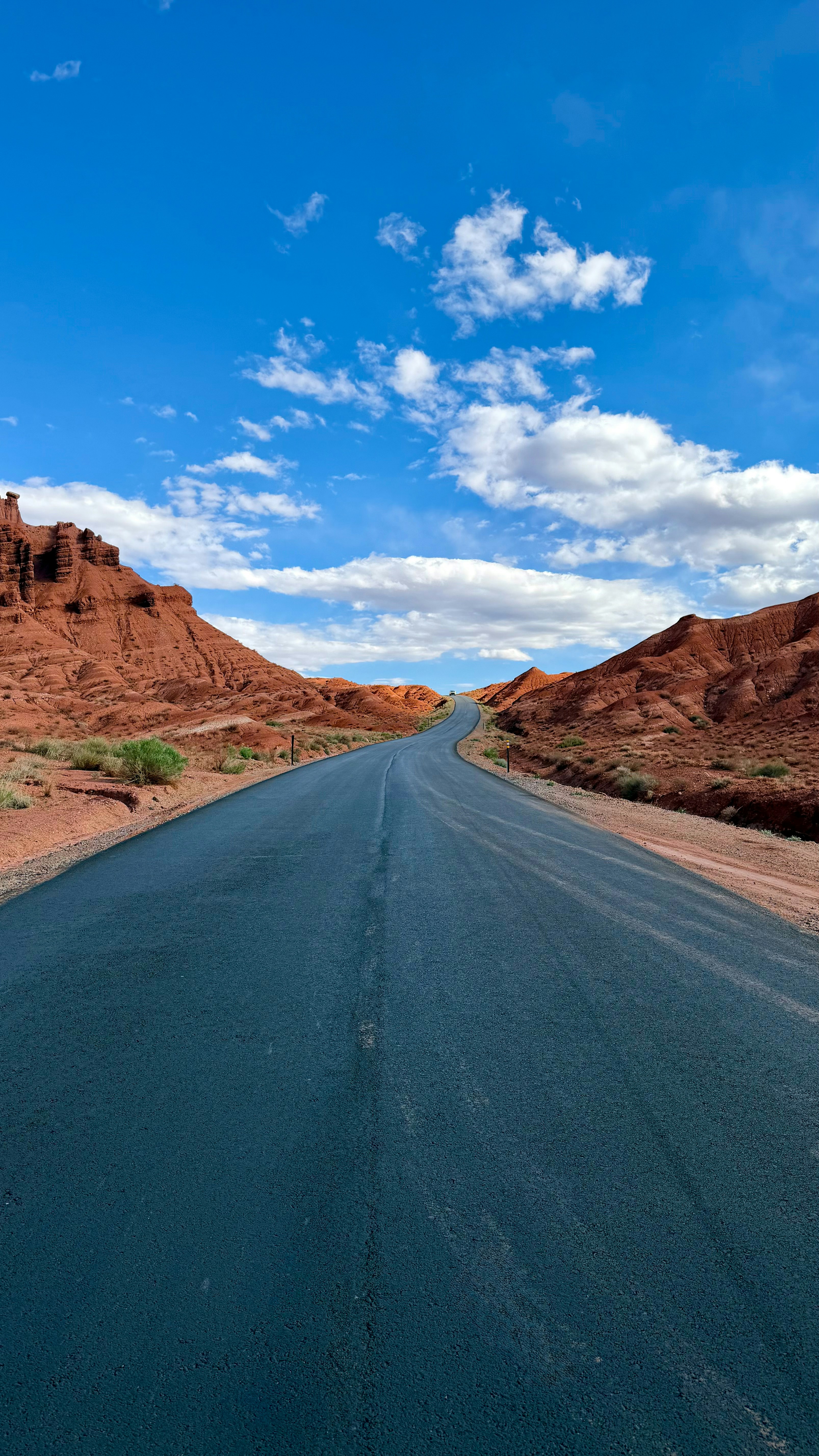 Desert Highway: A Meandering Asphalt Ribbon Through Red Cliffs