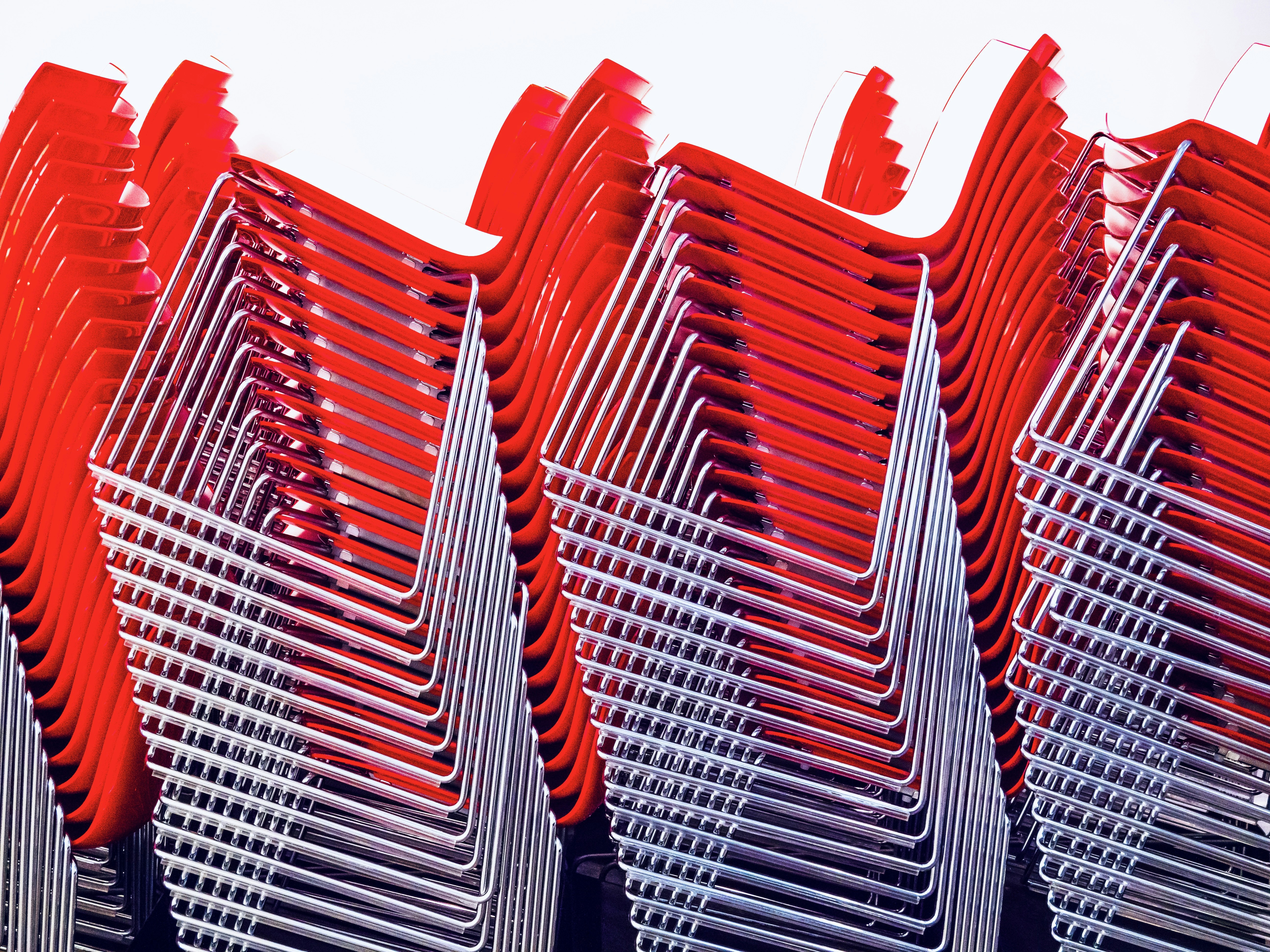Rows of Red Chairs: A Geometric Cascade of Color and Steel