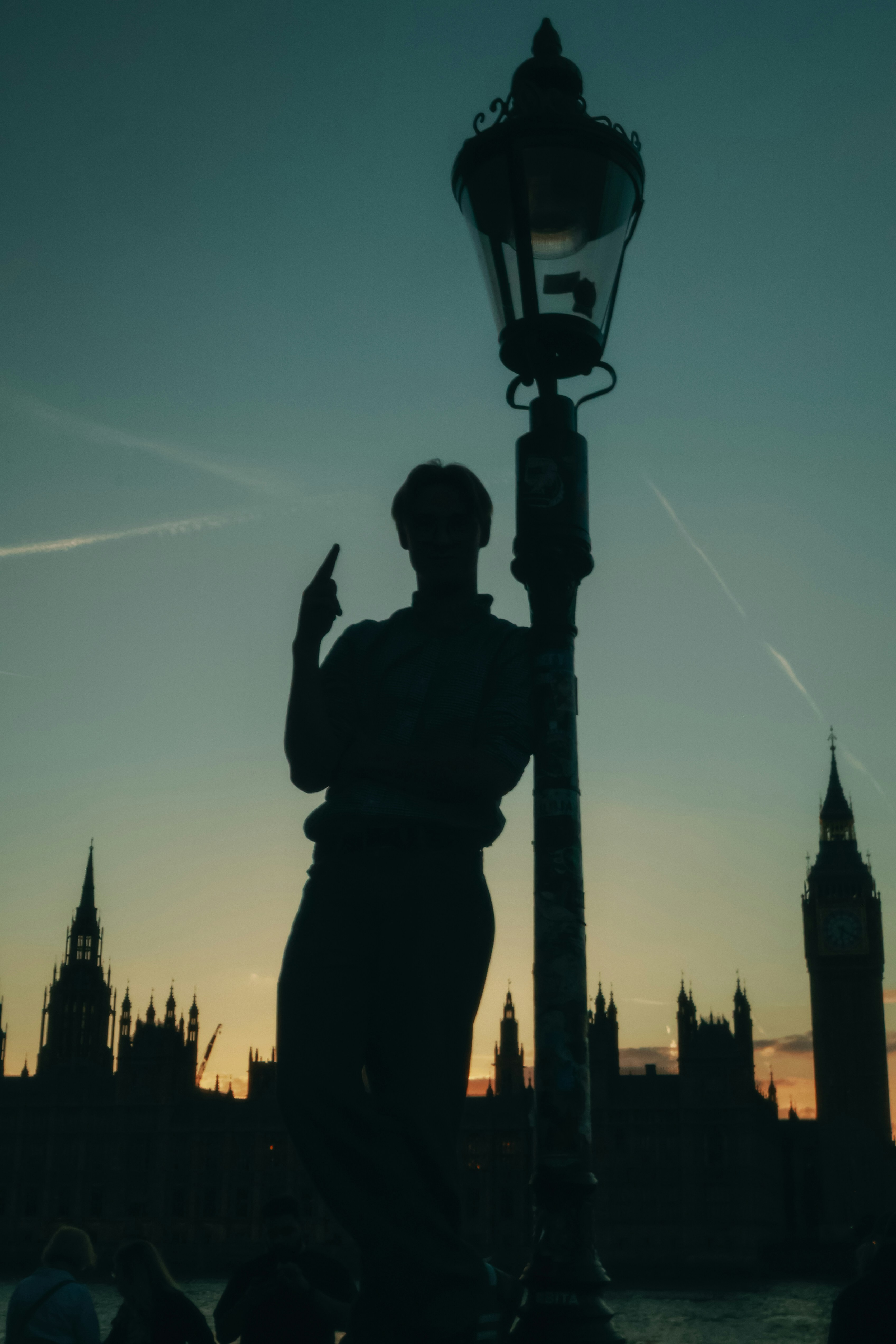 Silhouette at Dawn: A Night-Street Figure Beside the London Lamp