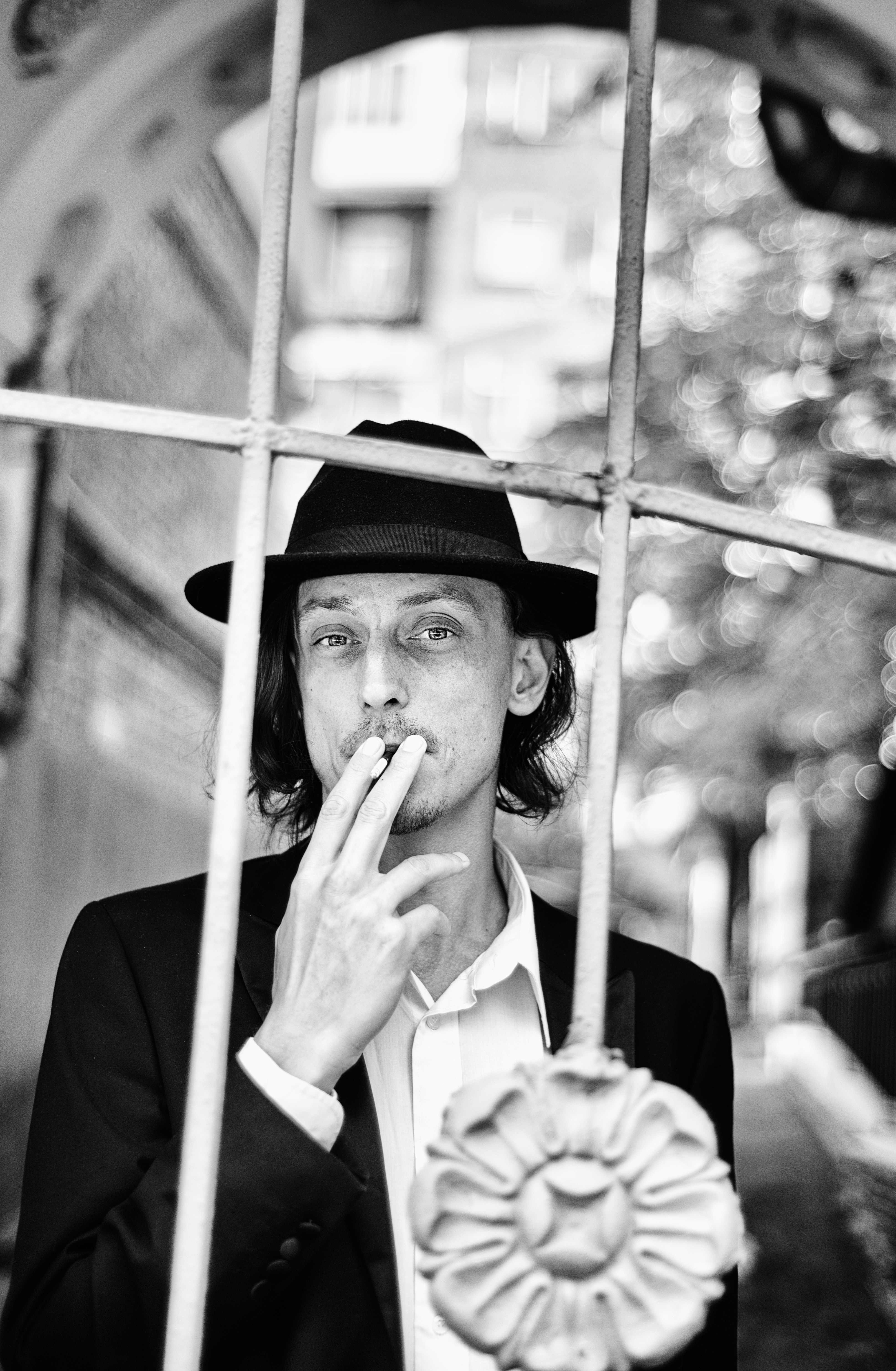 Barred View: The Cigar-Waiting Moment Behind Iron Grids
