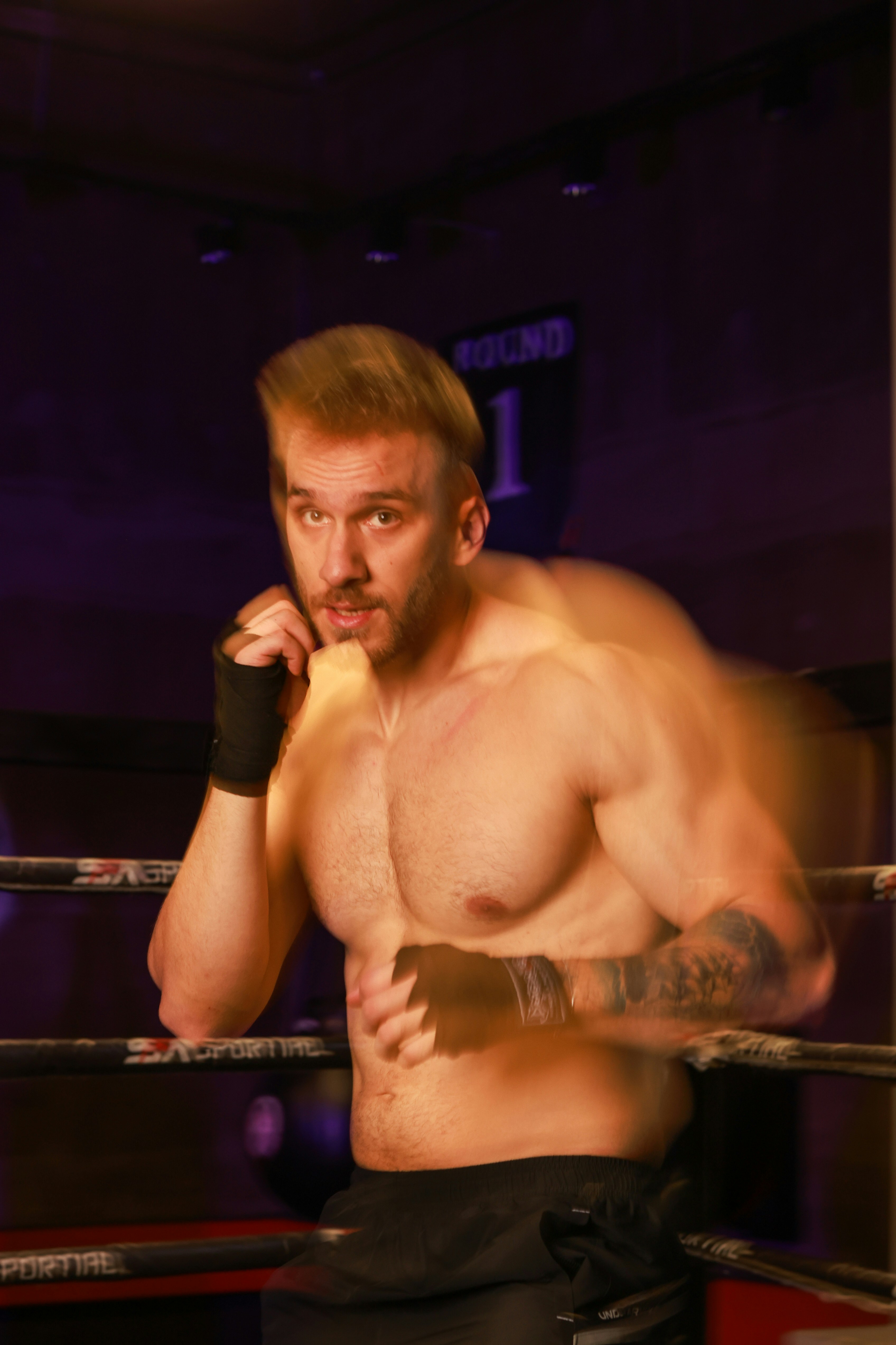 Mid‑Fight Focus: A Burly Boxer Emerges from Motion Blur