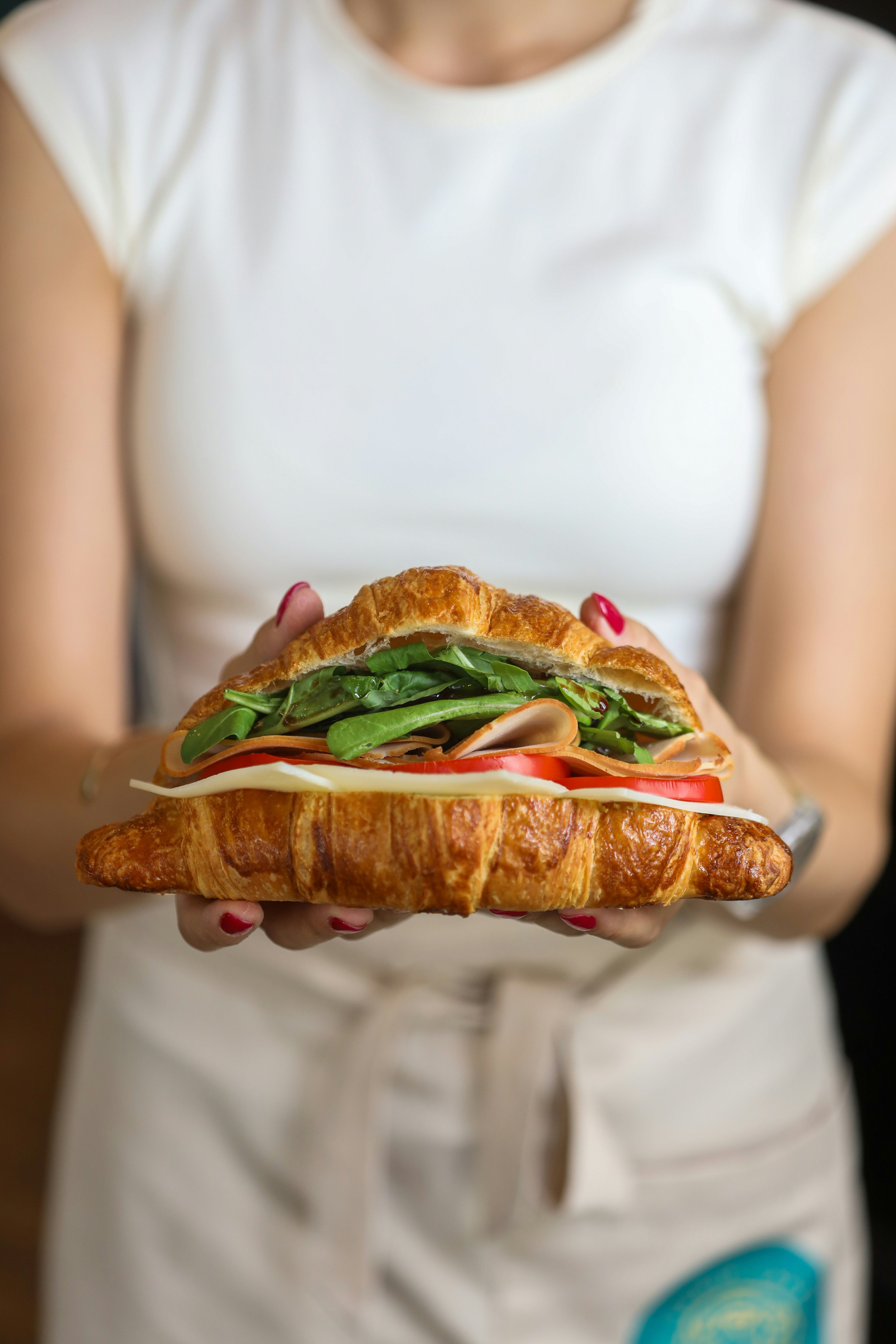 Cradled in Crunch: A Gourmet Croissant Sandwich Gracefully Presented
