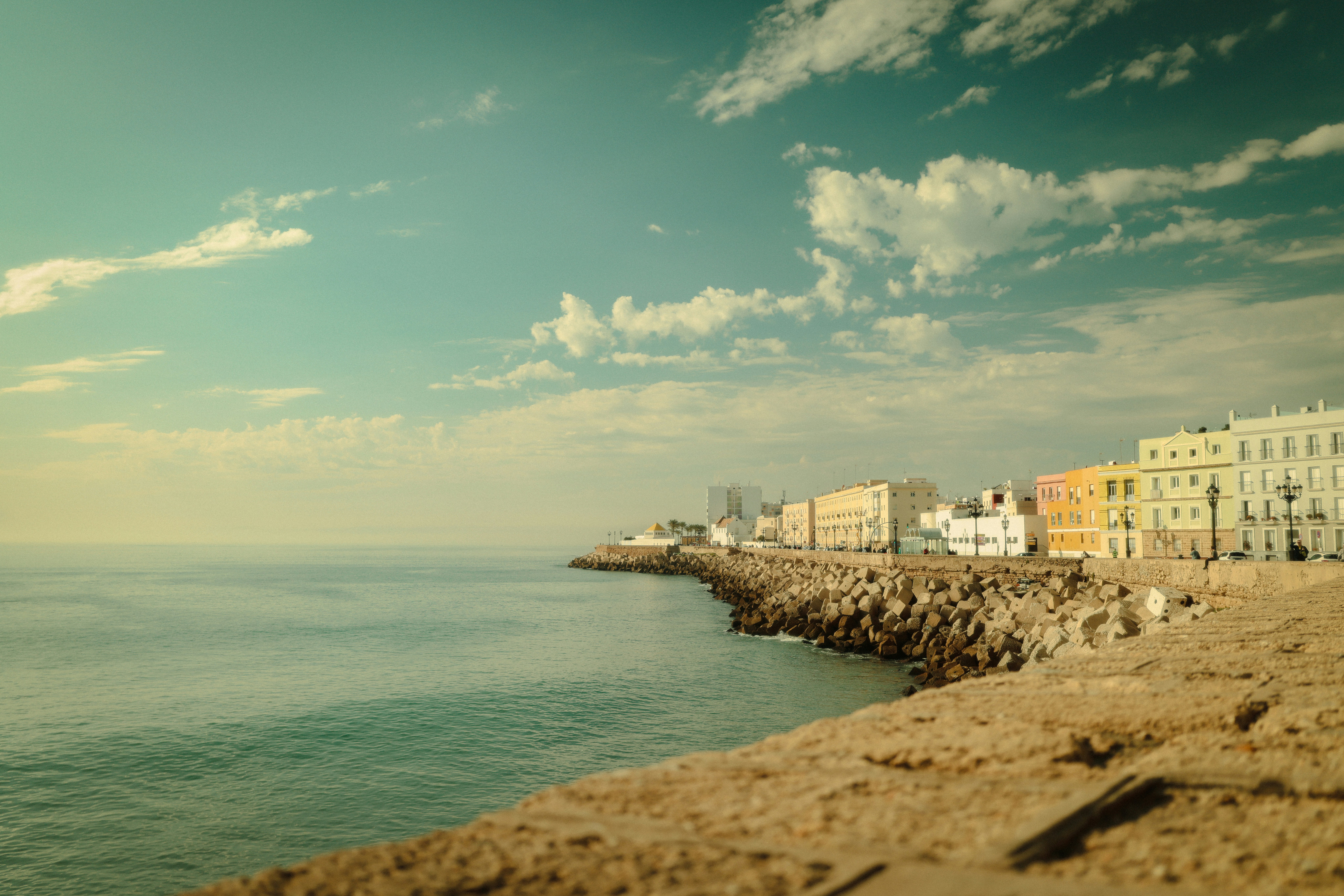 Harbor Row: Sunlit Coastal Homes Dapple the Breakwater