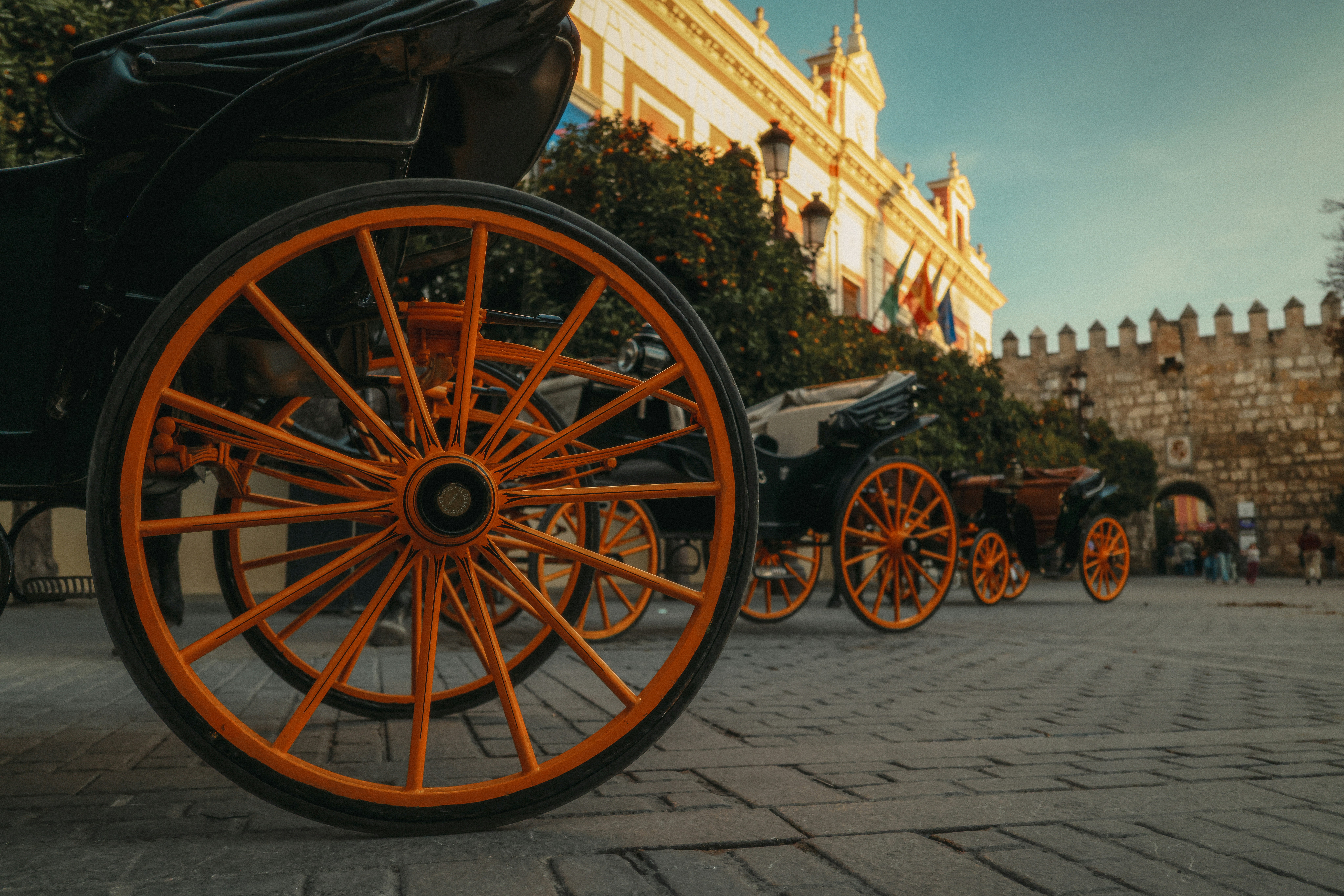 Orange-Wheeled Carriages at the Fortress Gate