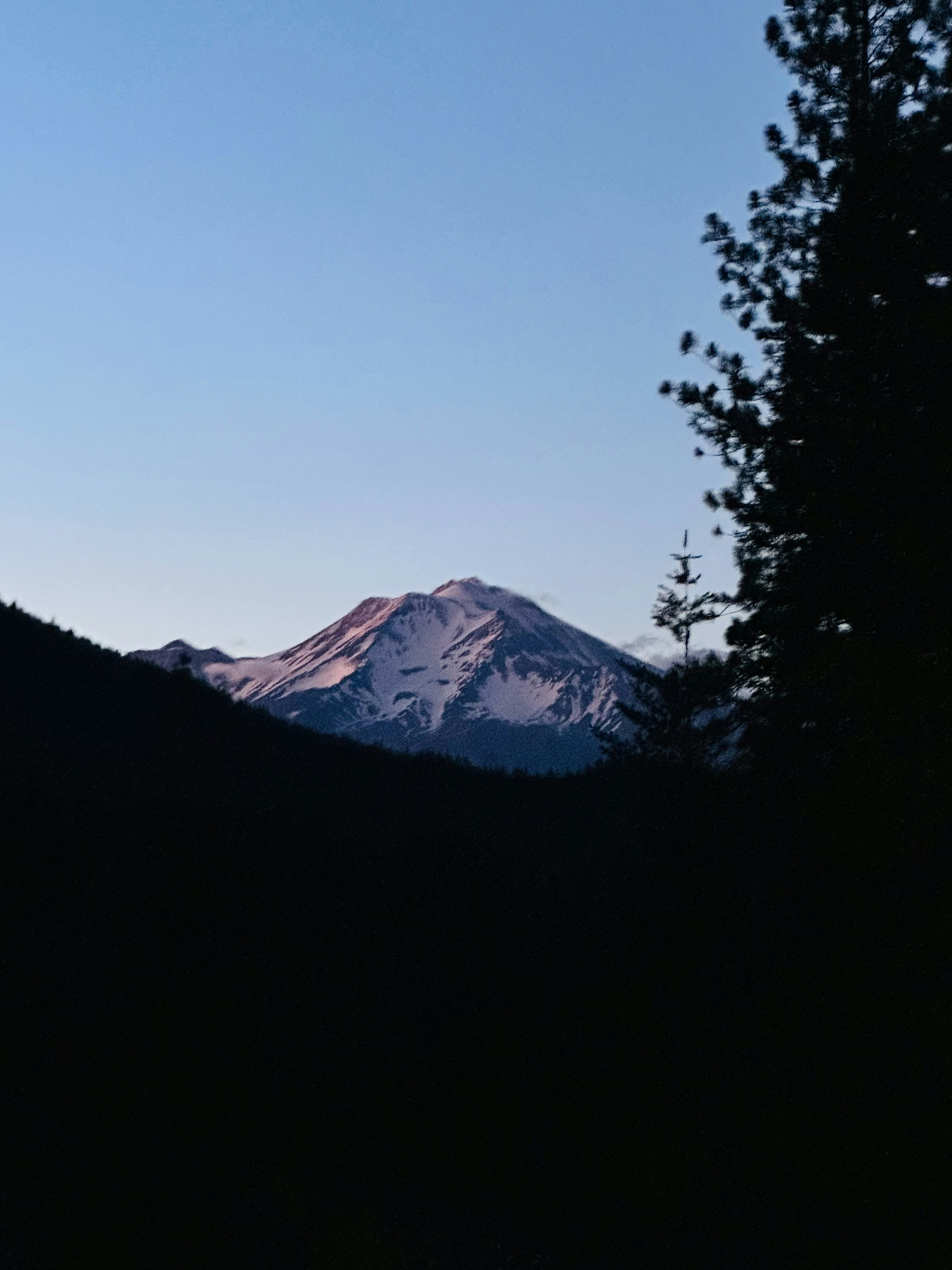 Dawn Snow Peak Rising Over a Dark Valley