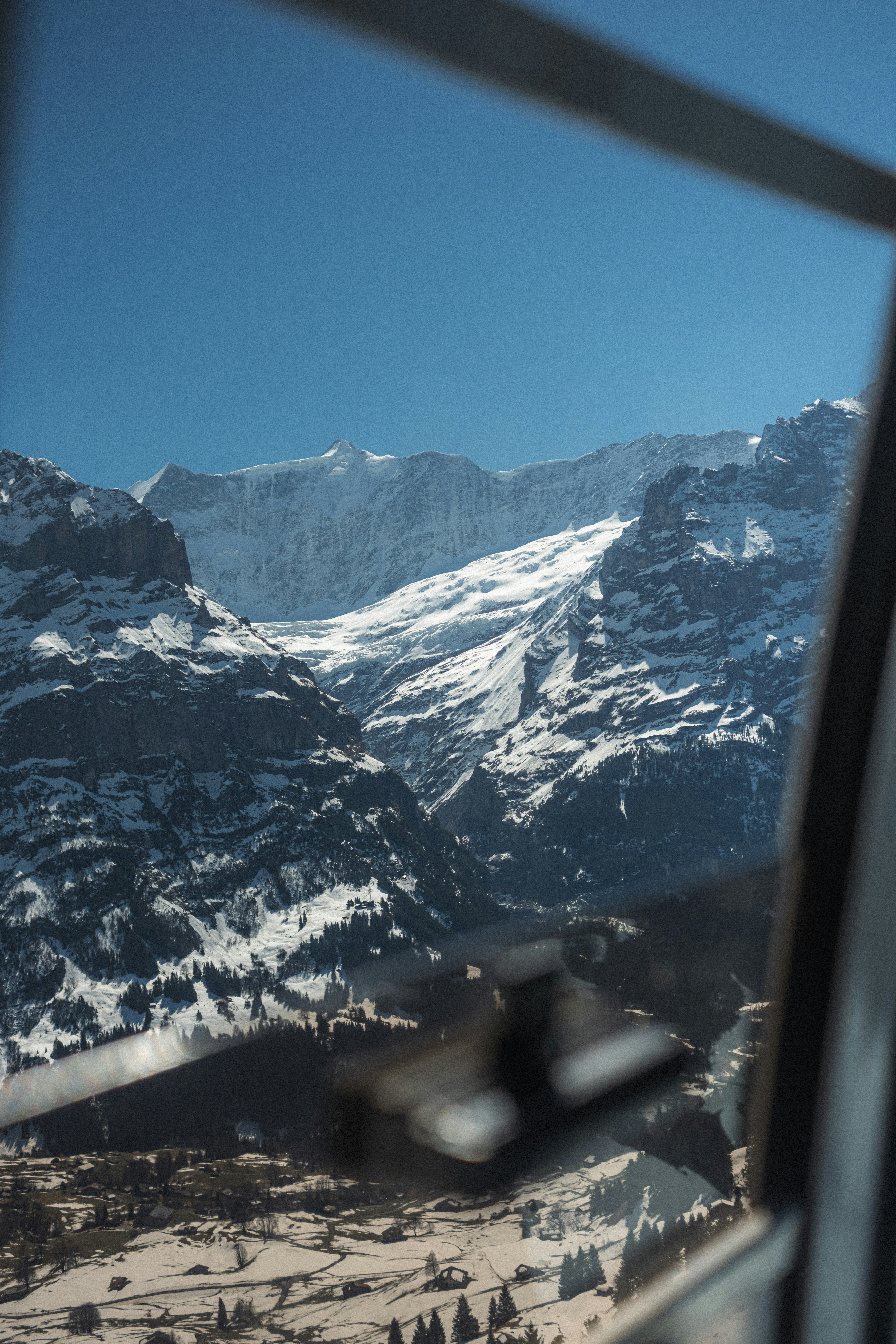 Snow-dusted Peaks Through a Cabin Window