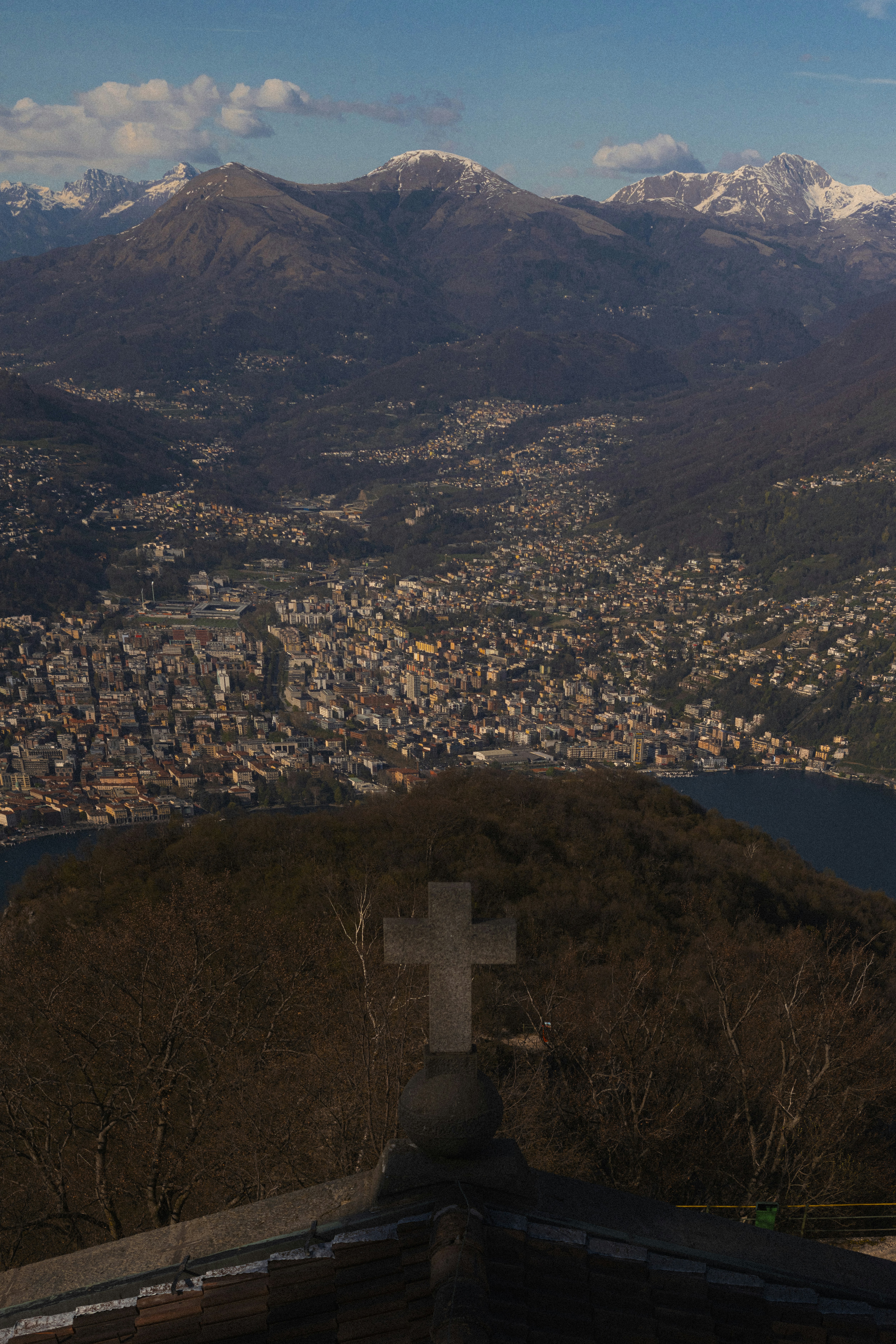 Cross on the Ridge Overlooking a Terraced City at Dusk