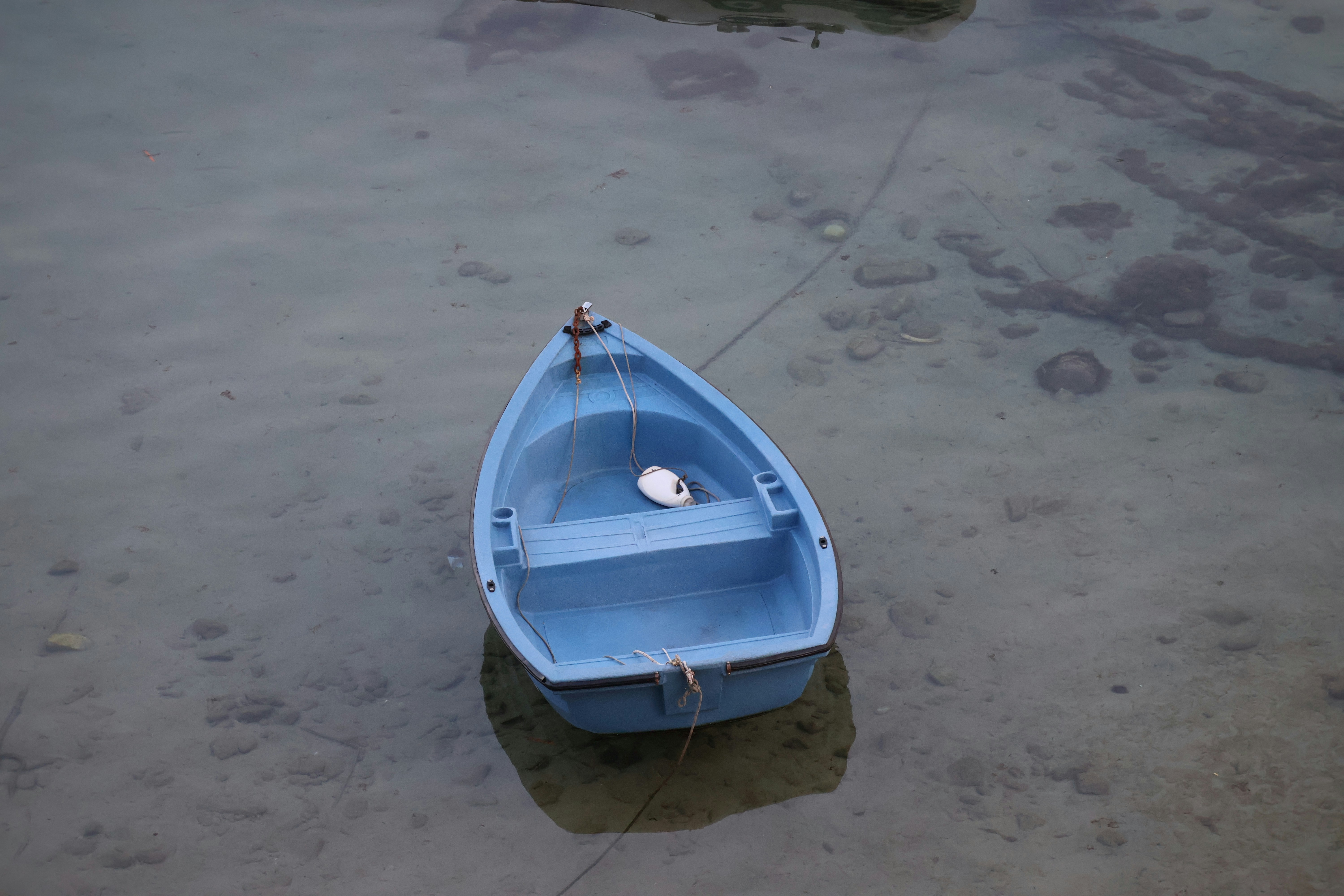 Blue Rowboat Clears a Quiet Tidal Pool