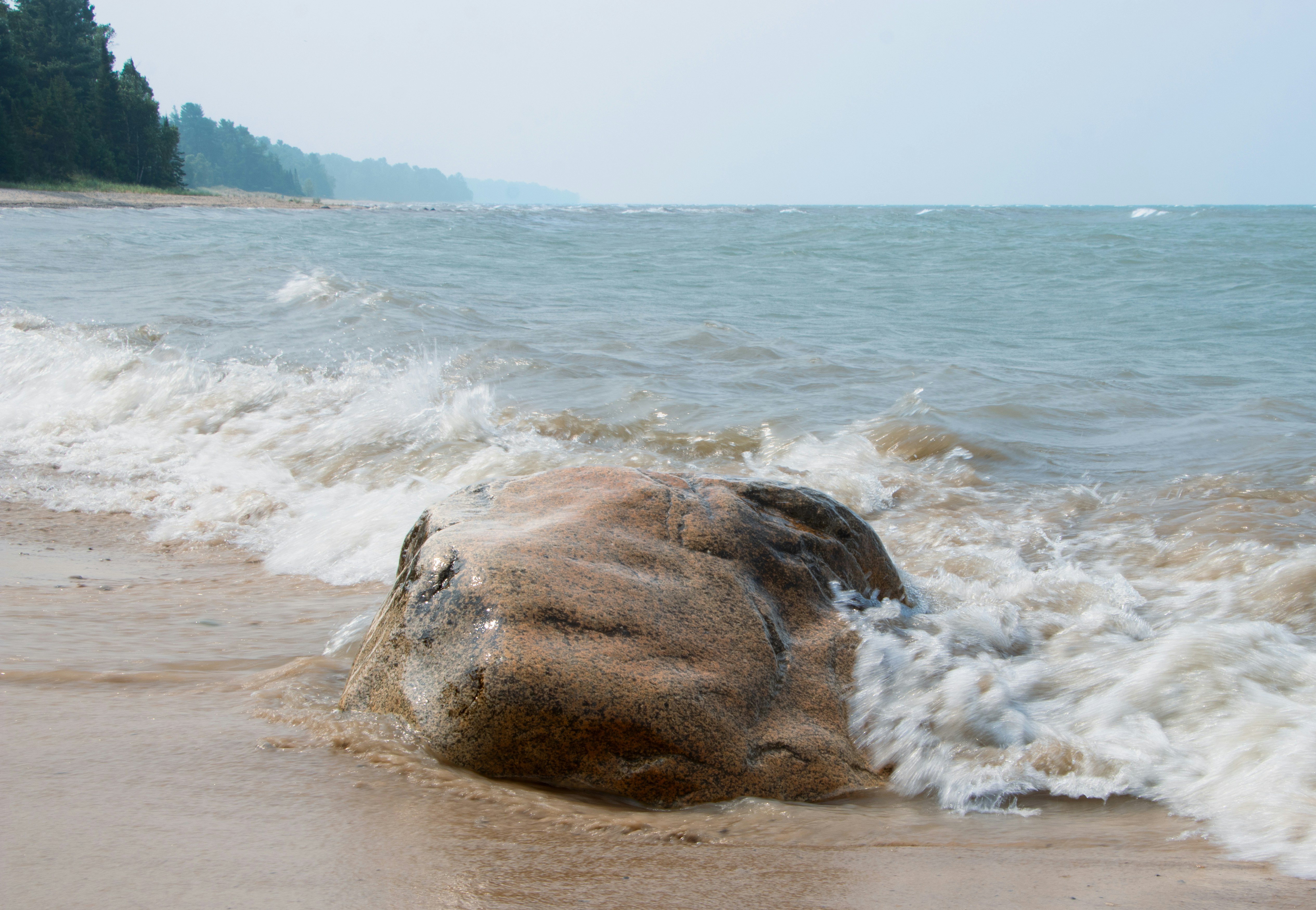 Rugged Rock Guarded by Ocean Foam on a Quiet Shore