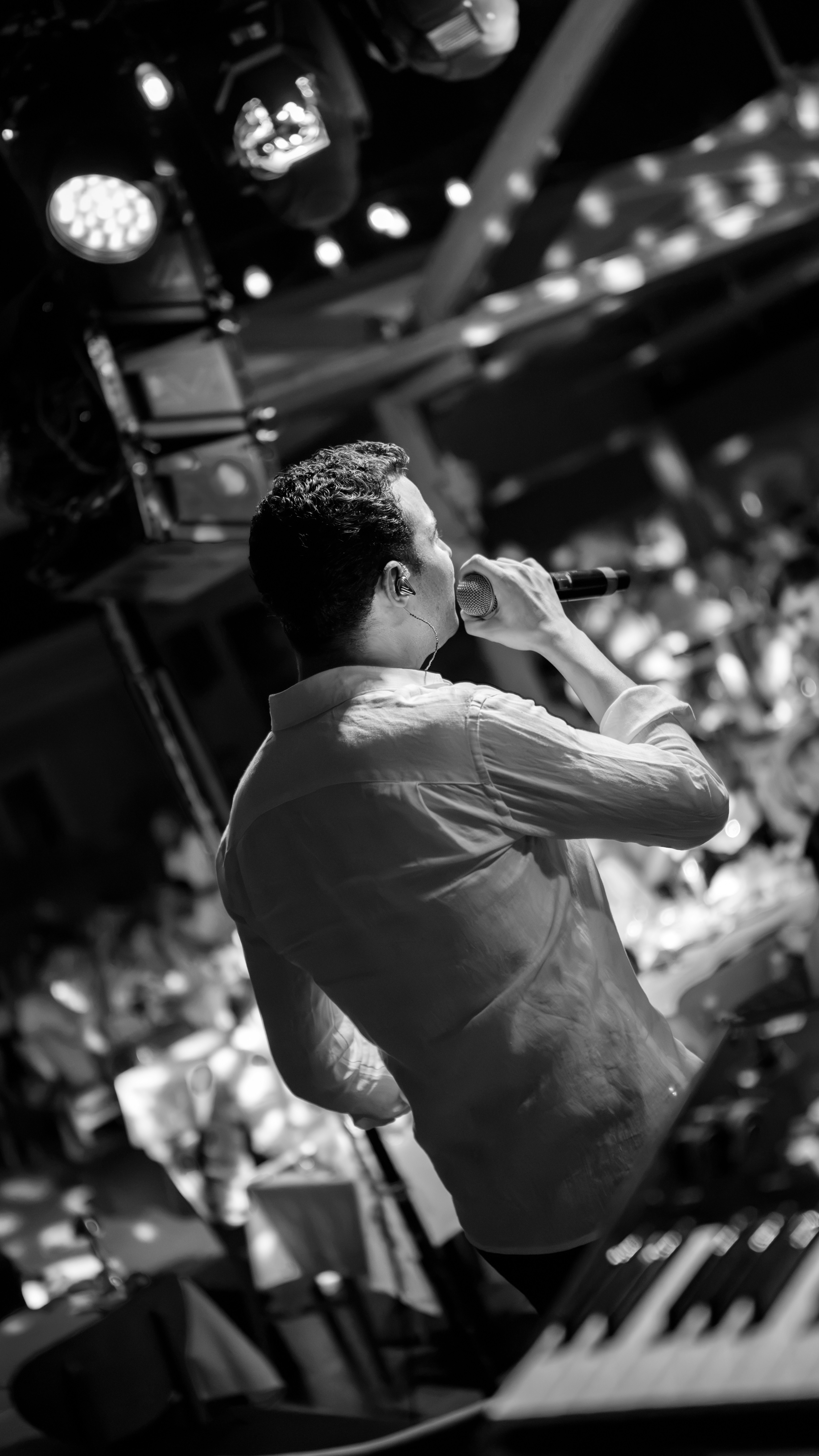 Backlit Microphone: A Singer's Shadow on Stage