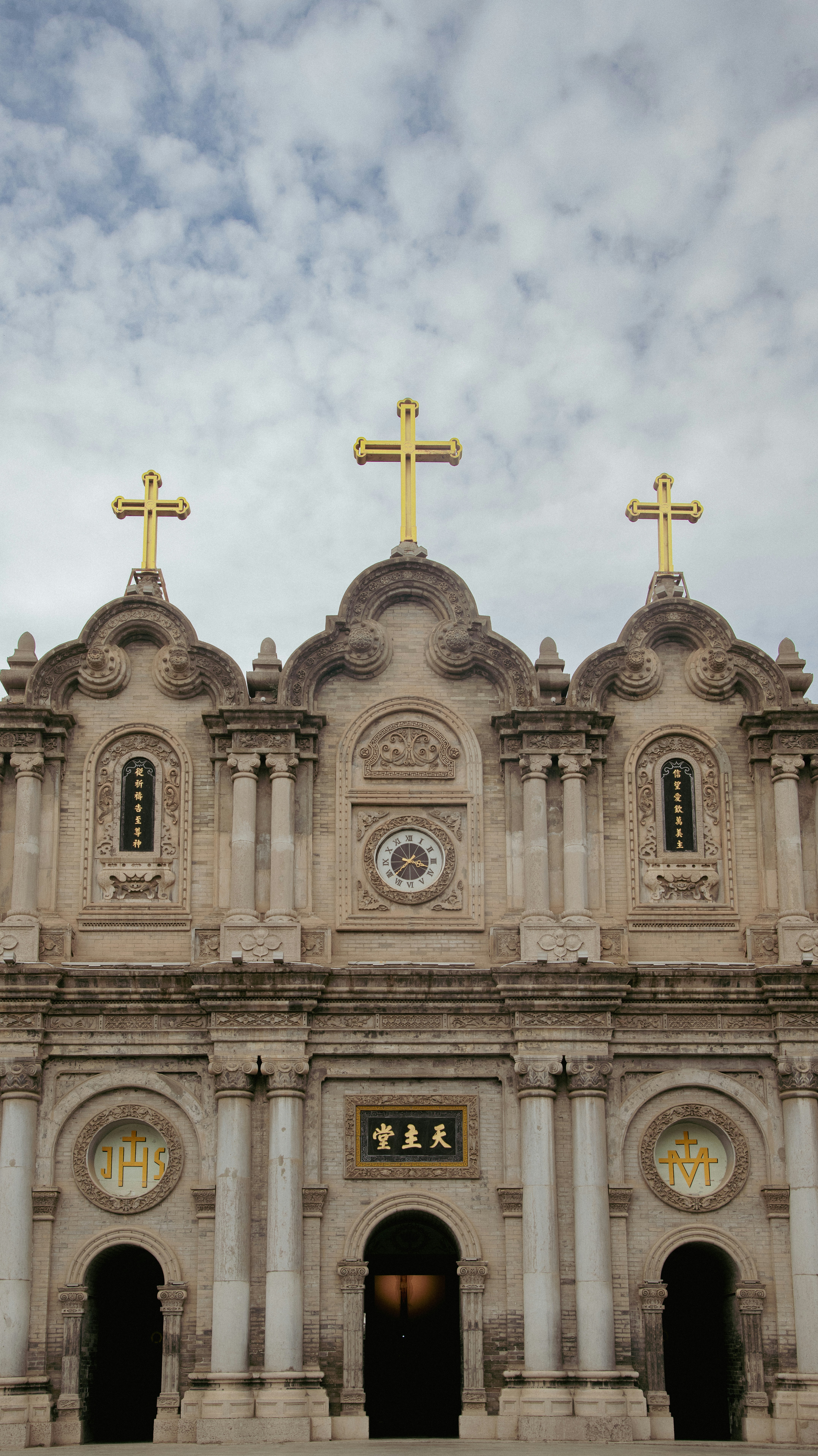 Golden Crosses Over the Stone Facade