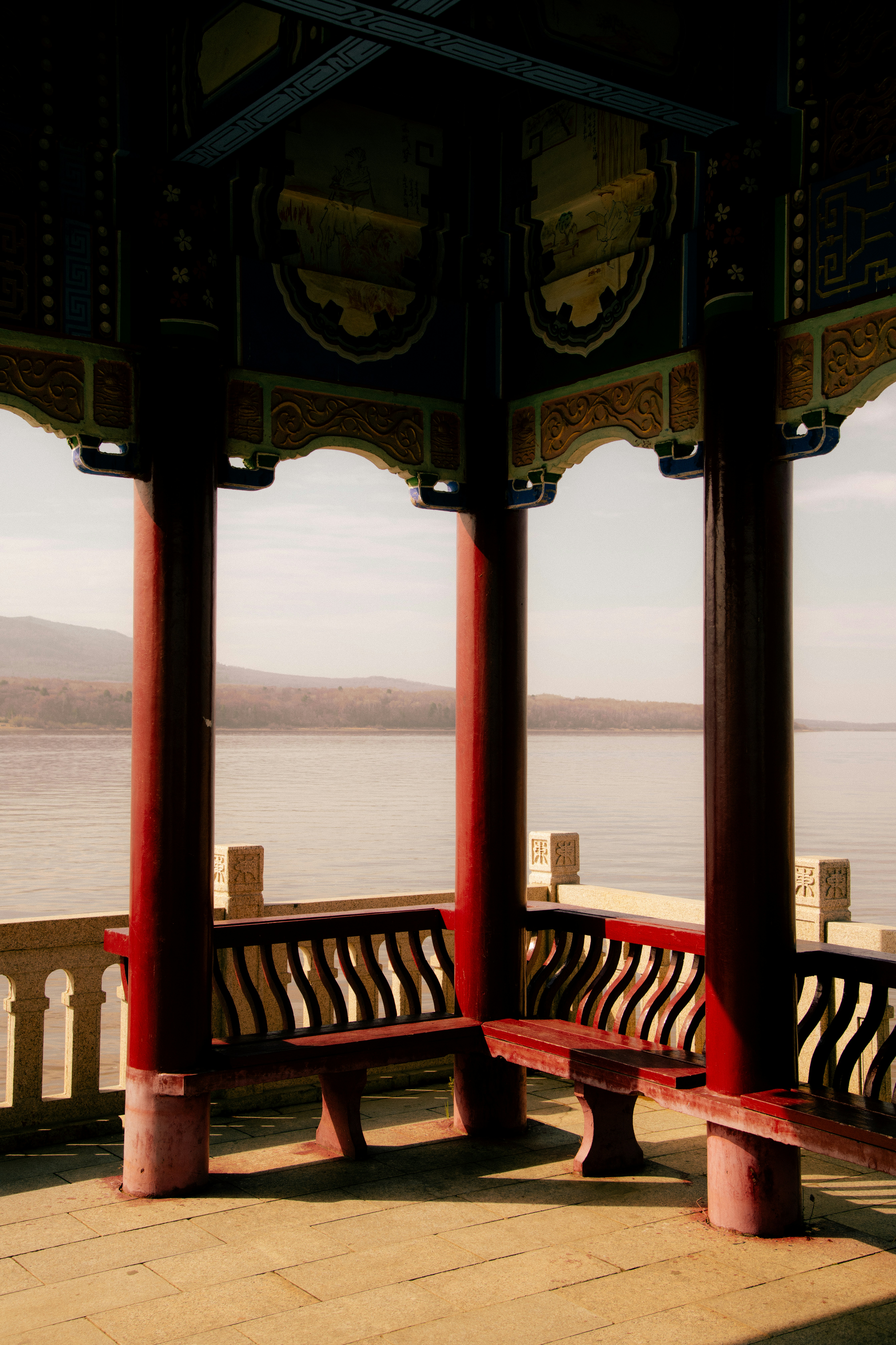 Red Columns and Deserted Lake: A Quiet Pavilion Overlook