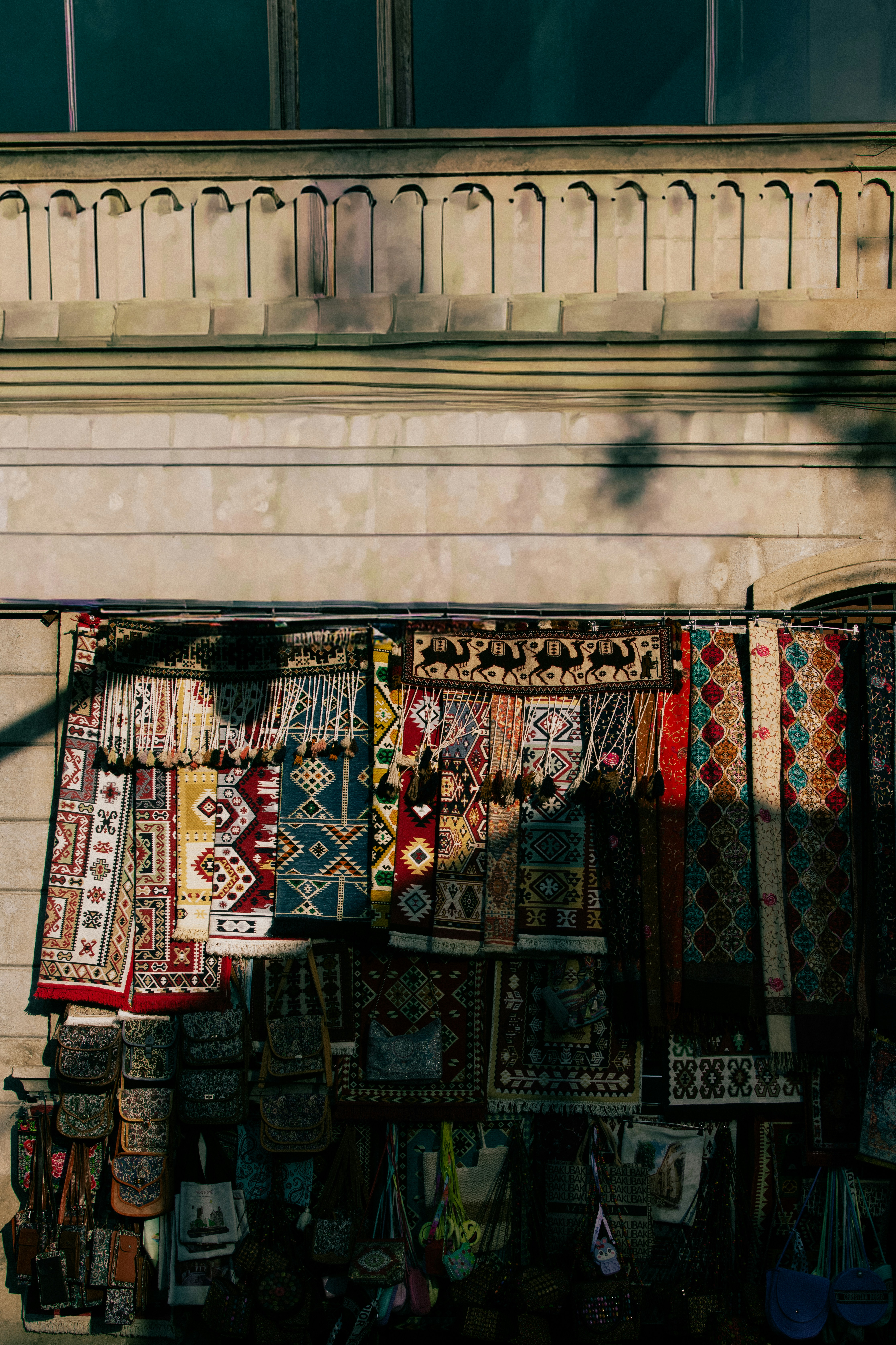 Colorful Textile Market Under Wall Shadows