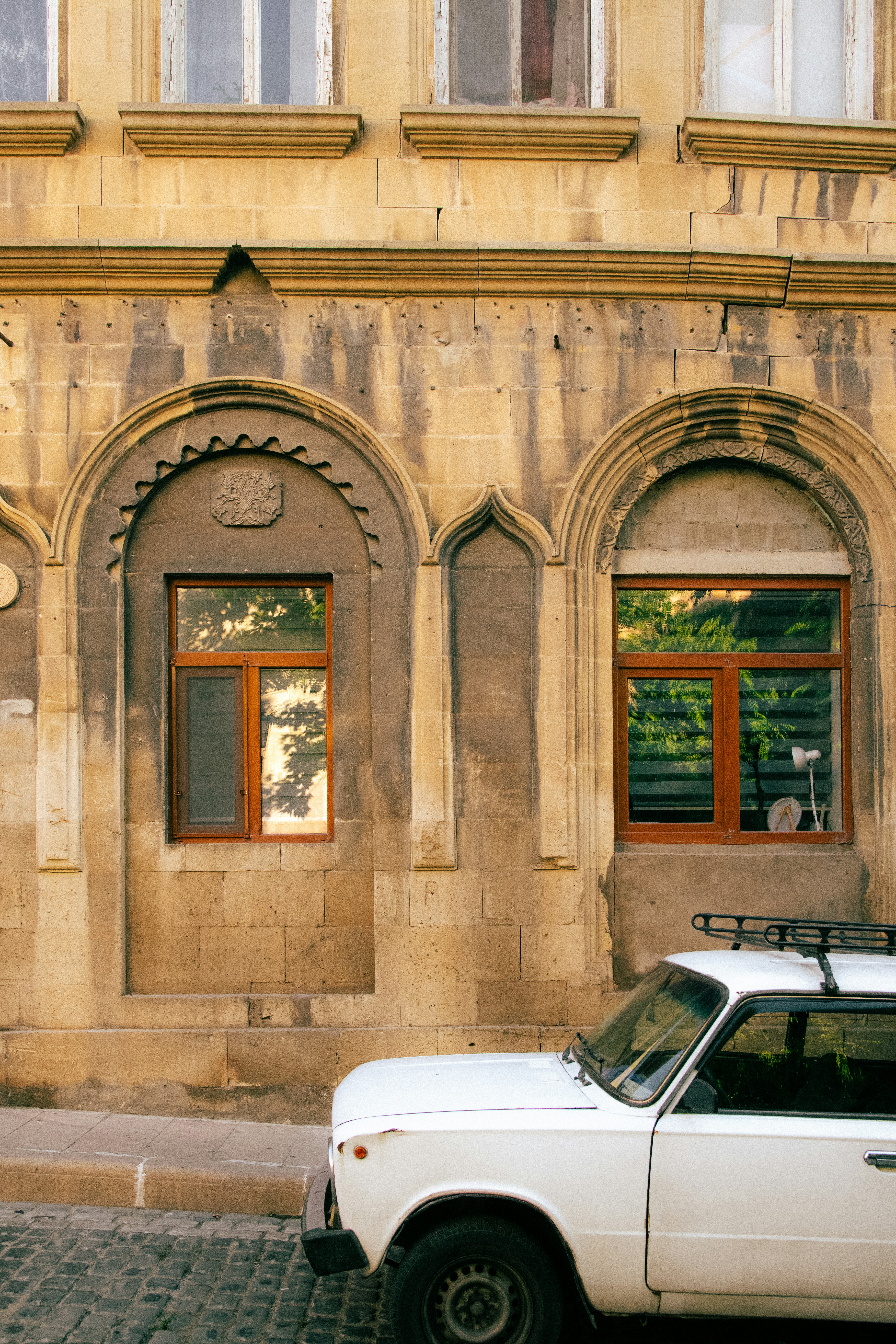 Old Streetcar Serenade: A Vintage Car Against Arched Facades