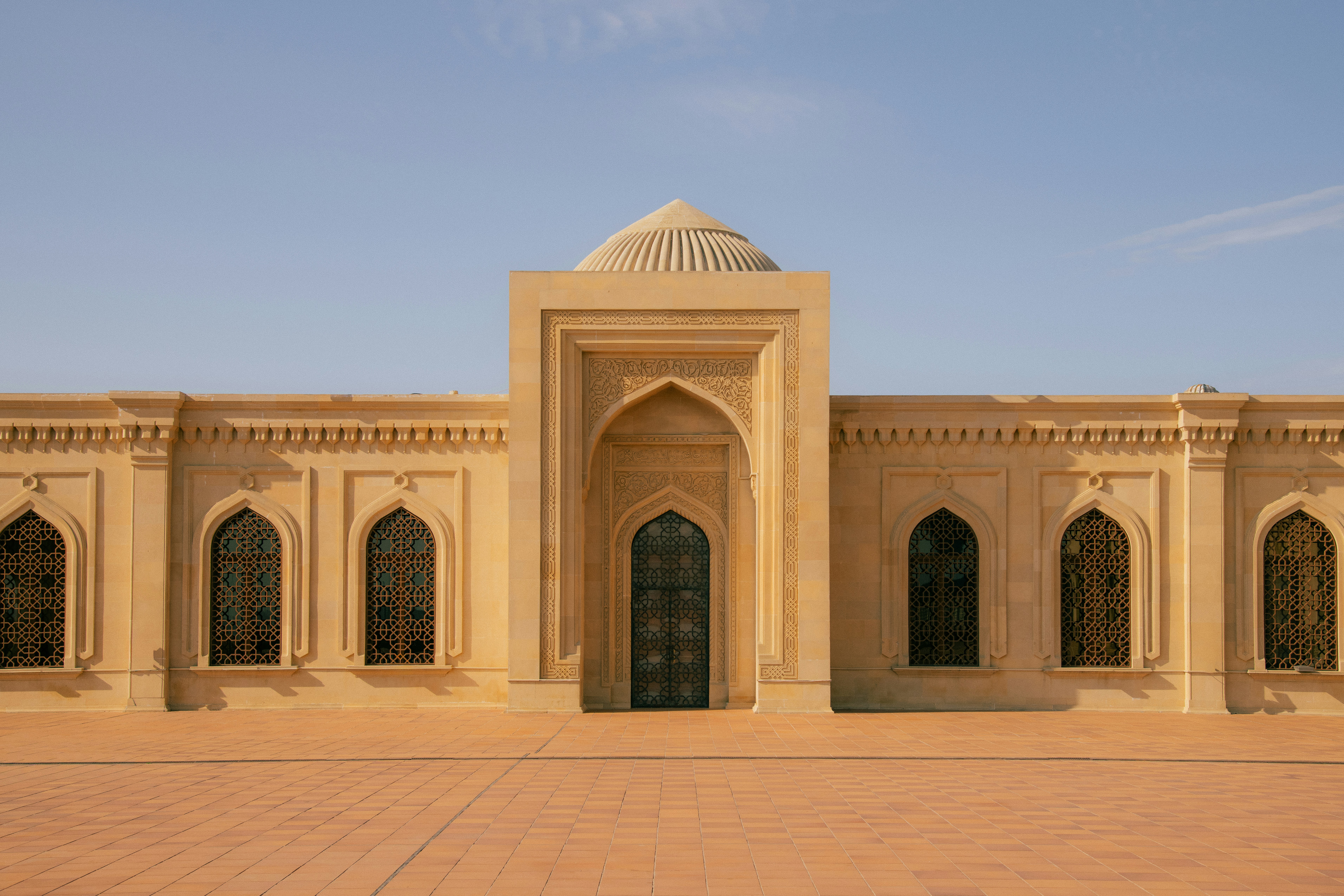 Central Archway Dominates a Desert-Colored Courtyard