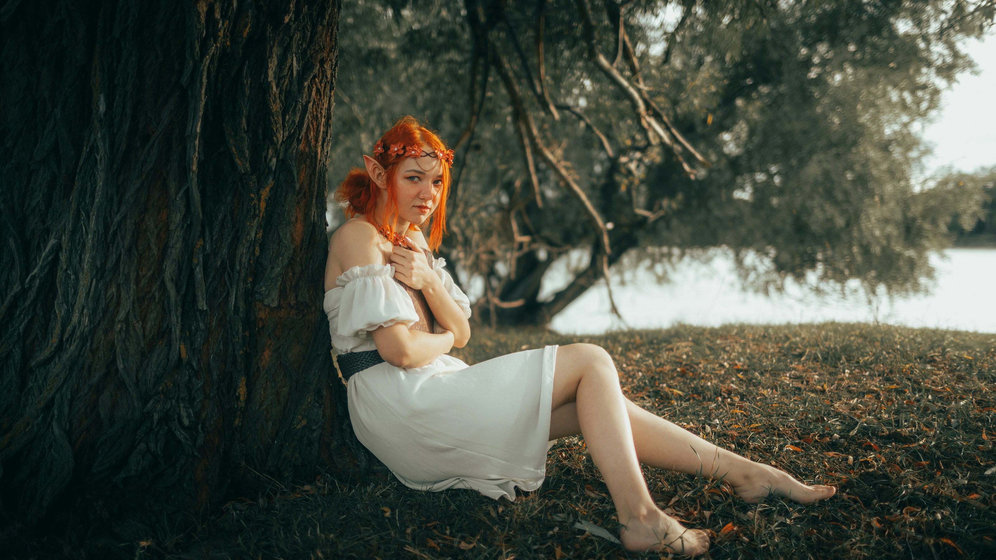 Red-haired Muse Under the Oak: A Quiet Moment in Dappled Light
