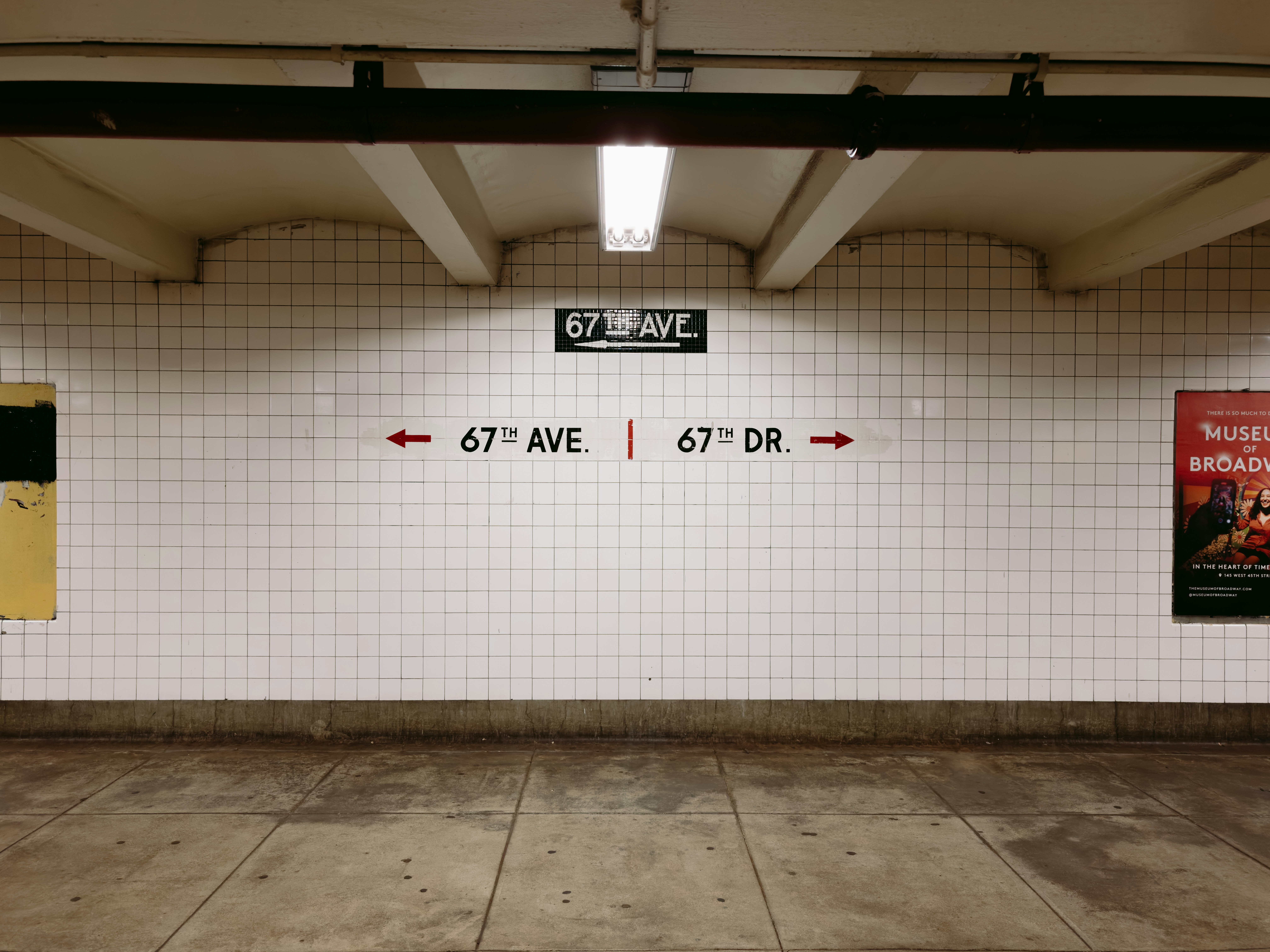 Where Two Avenues Meet: Suburban Subway Wall with Directional Signage