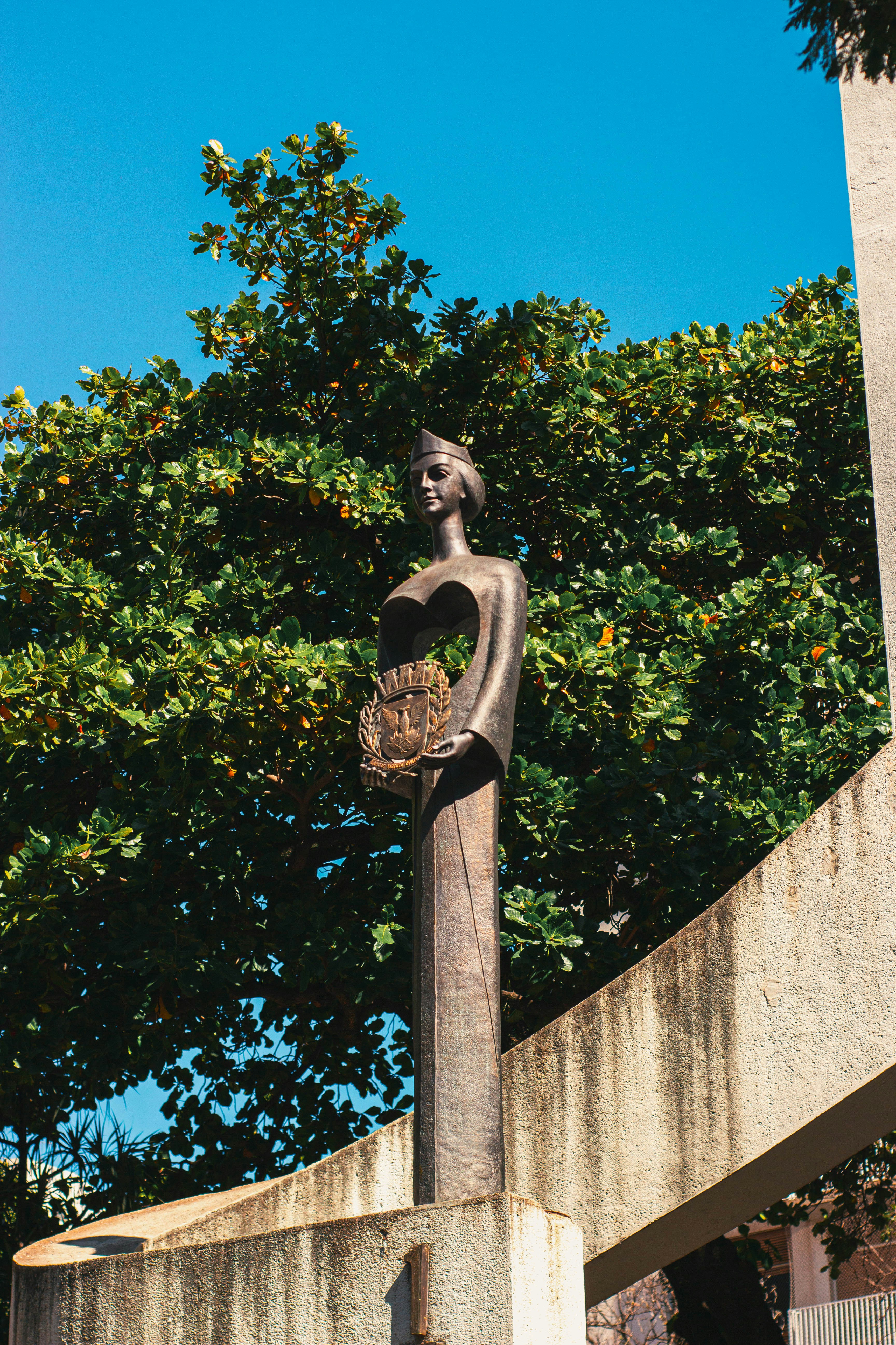 Statue Sentinel Above the Sunlit Steps