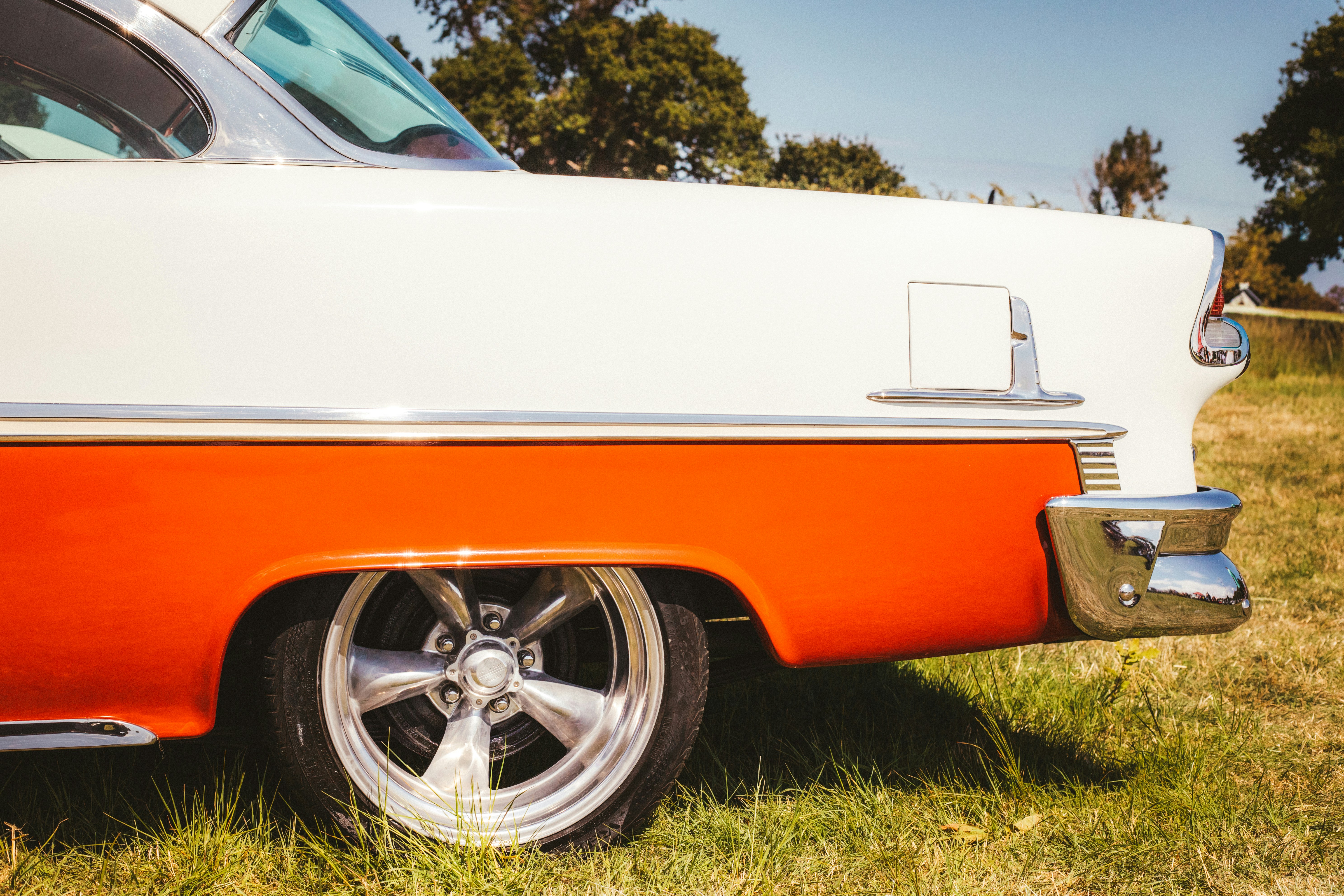 White-and-Orange Classic: Sunlit Tailfin and Chrome Wheel