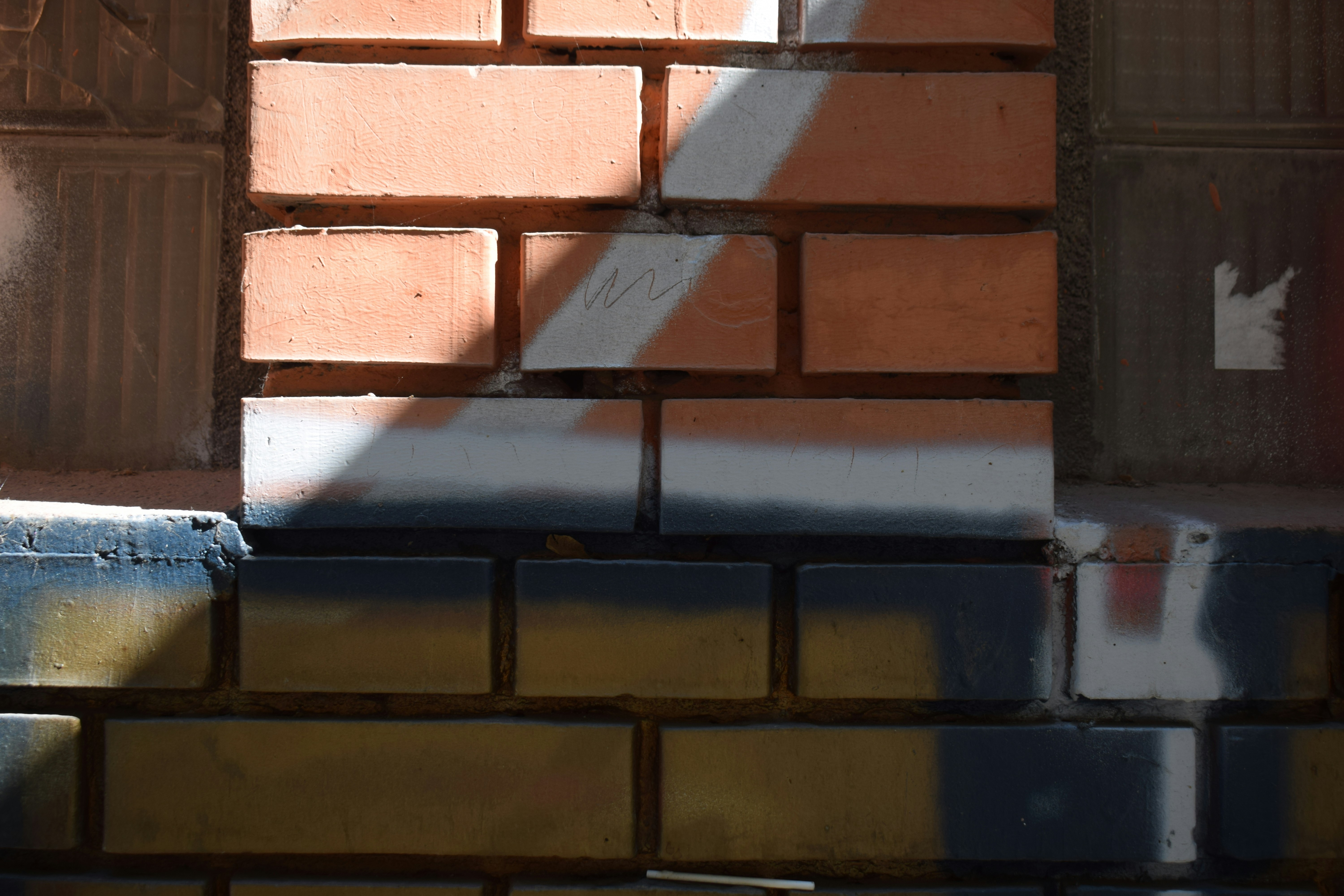 Brickwork in Shadow: Graffiti-tinged Wall with Sunset Light