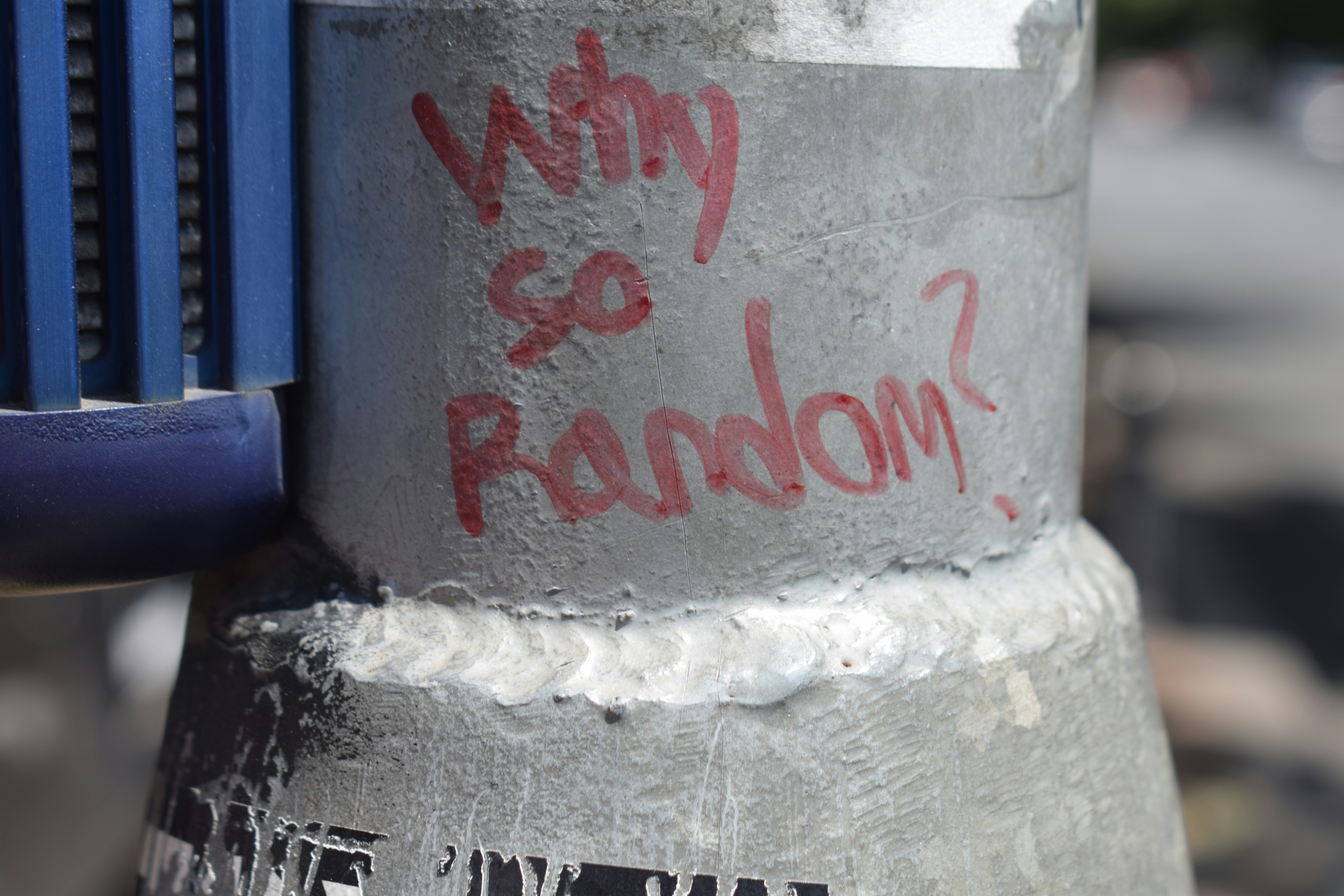 Why So Random? A Graffitied Post on a Weathered Streetlight