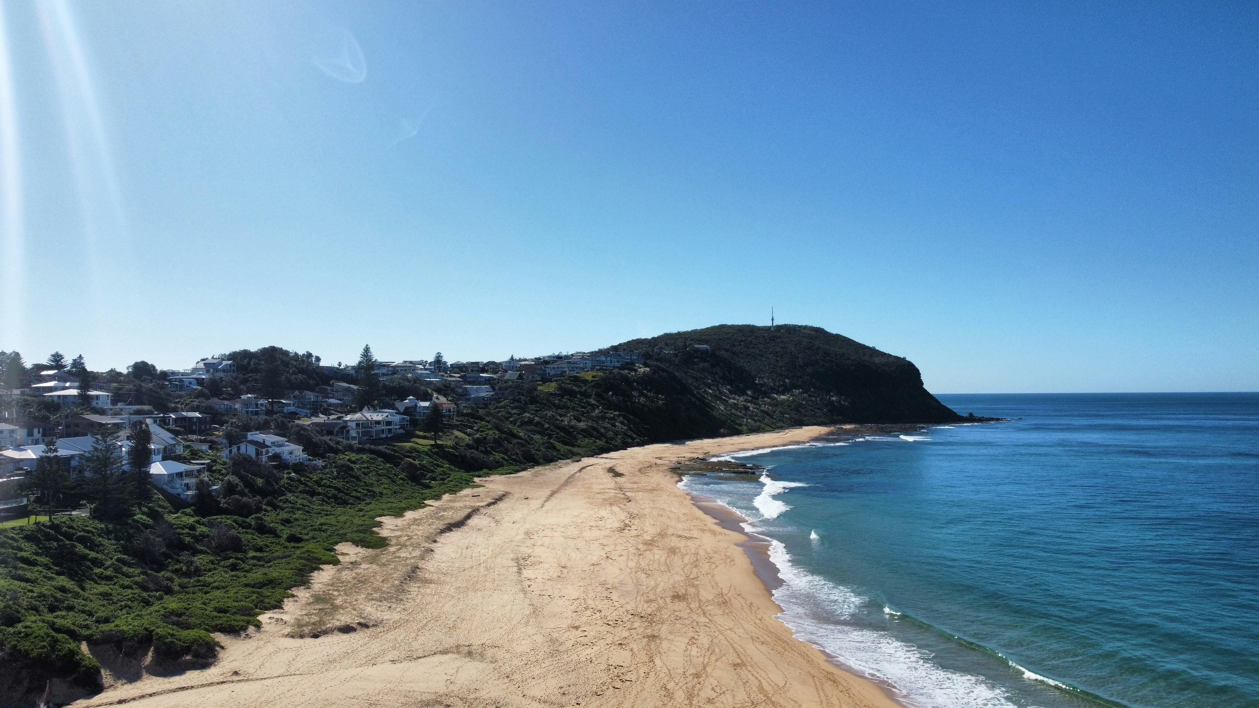 Coastal Ridge: A Sunlit Peninsula Framing a Quiet Sea