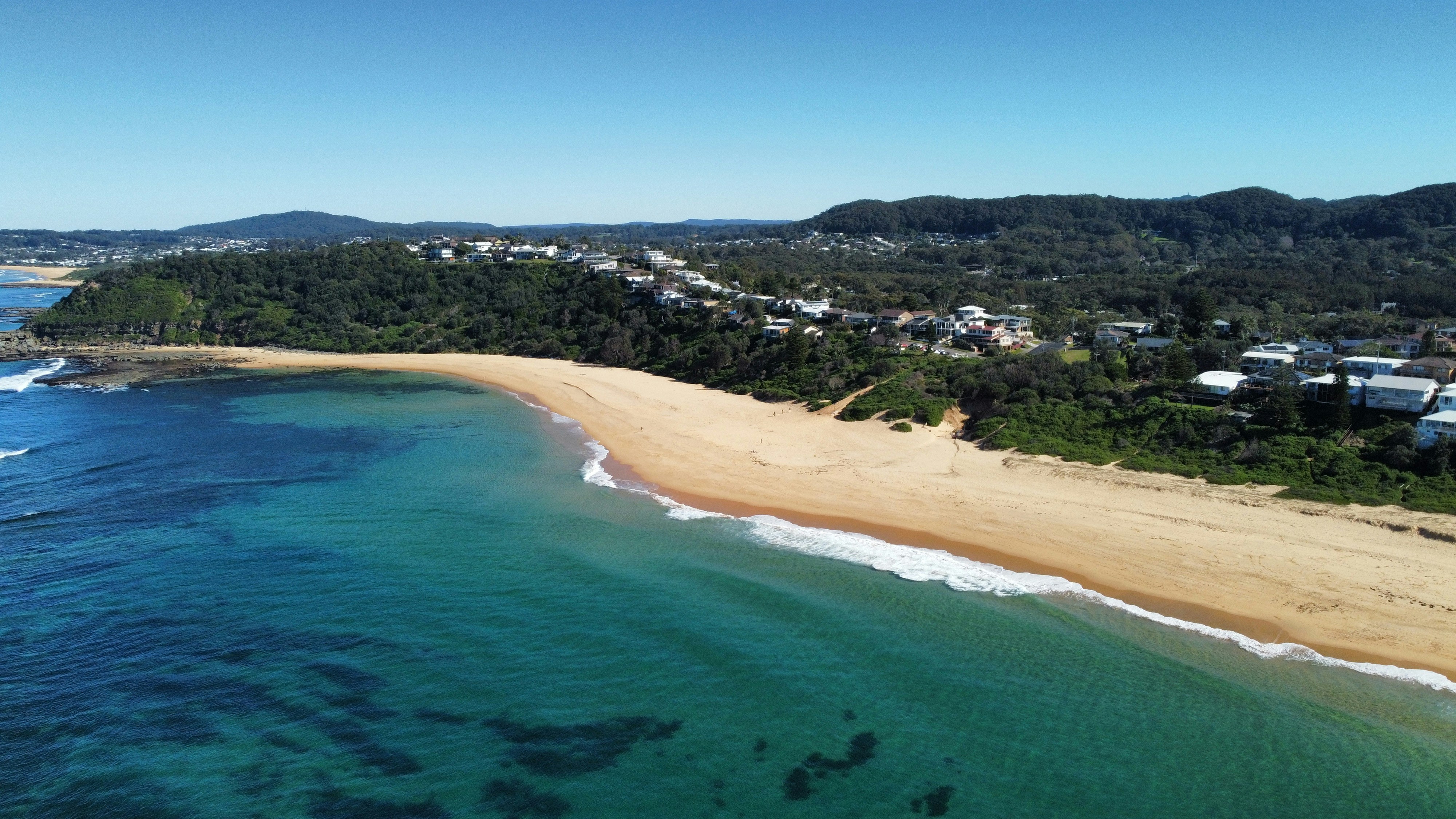Coastal Ribbon: A Quiet Beach Carved by Blue Waters