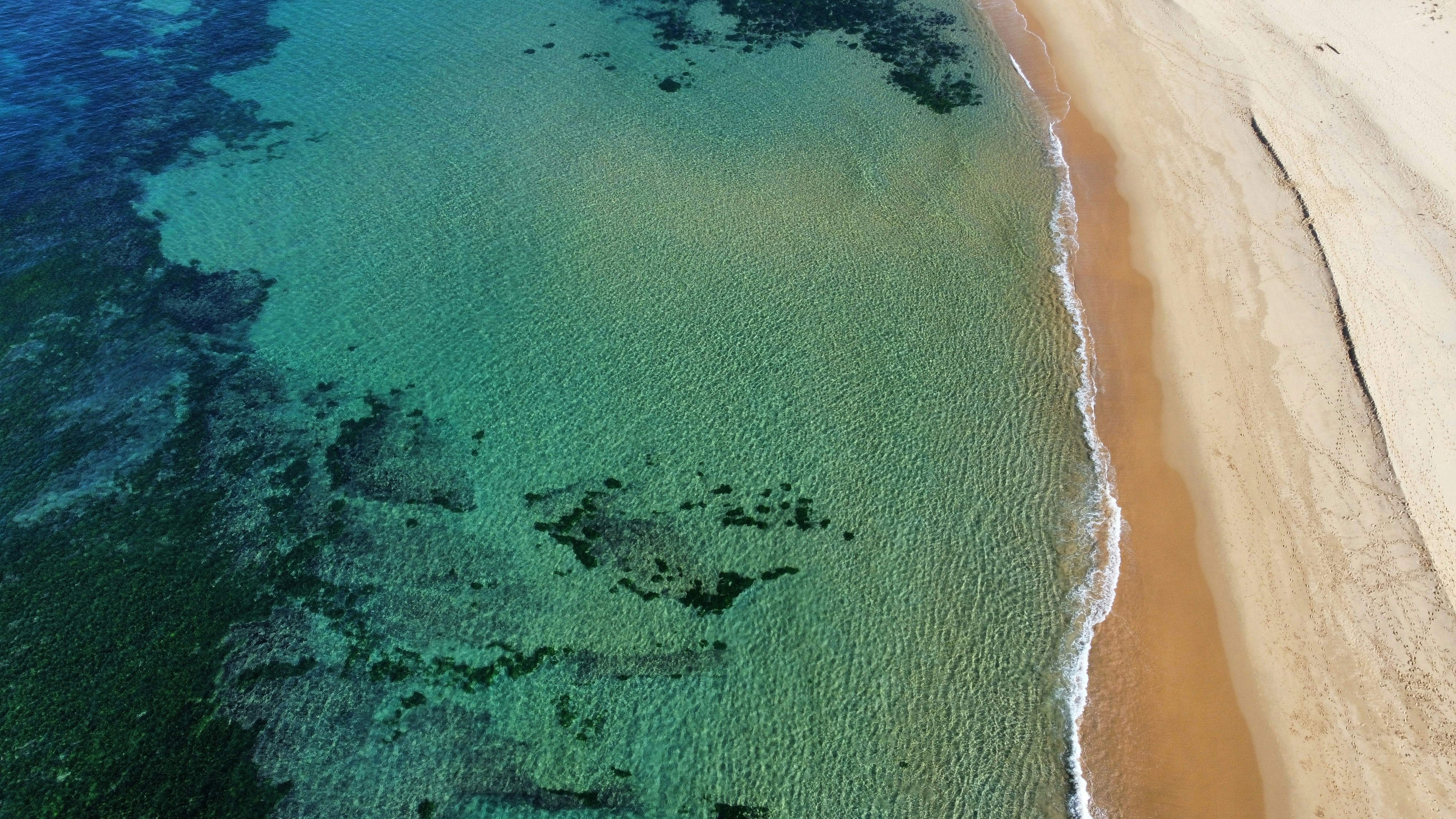 Emerald Coastline: Aerial Ribbon of Sea and Sand